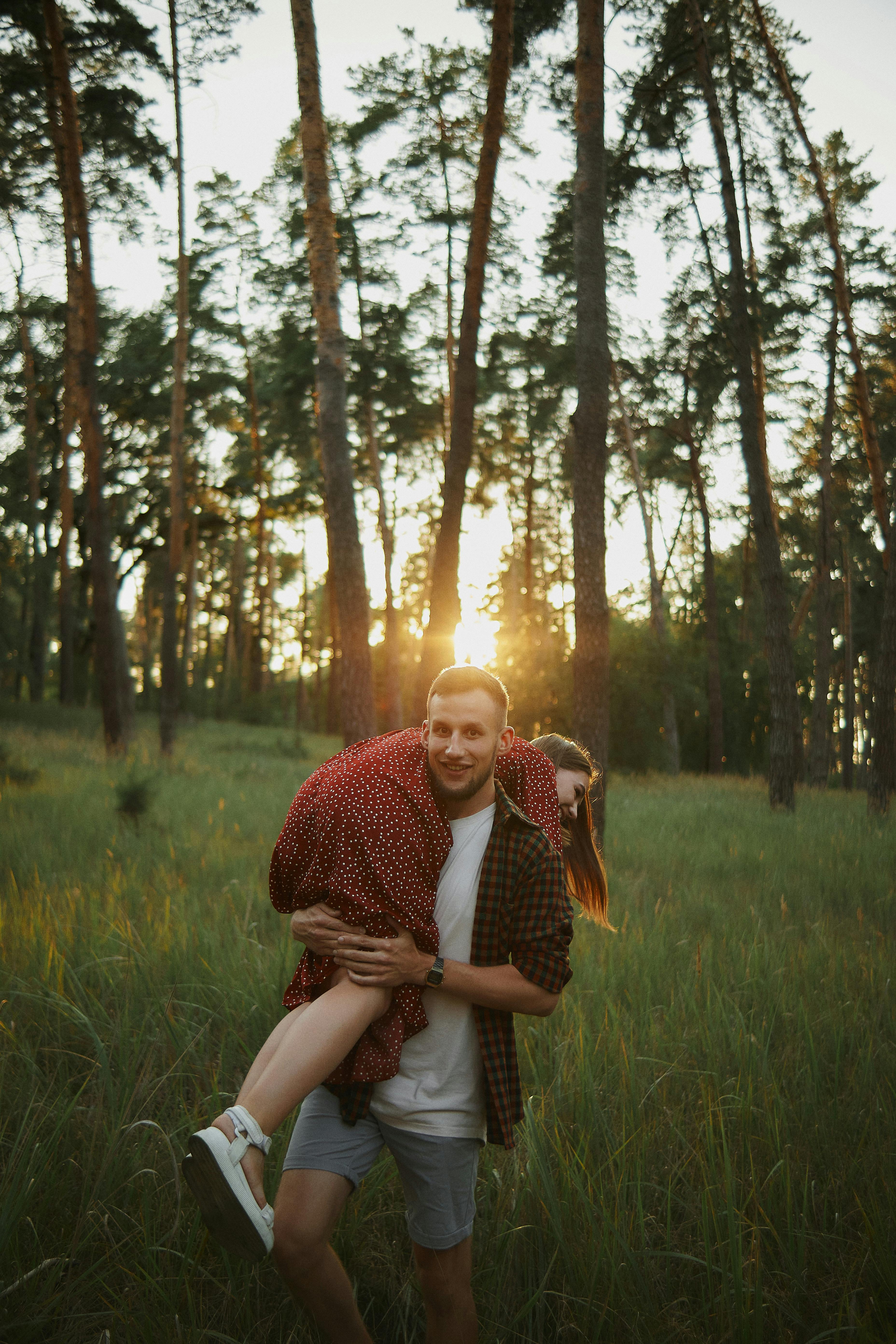 Man Carrying Woman Over his Shoulder · Free Stock Photo