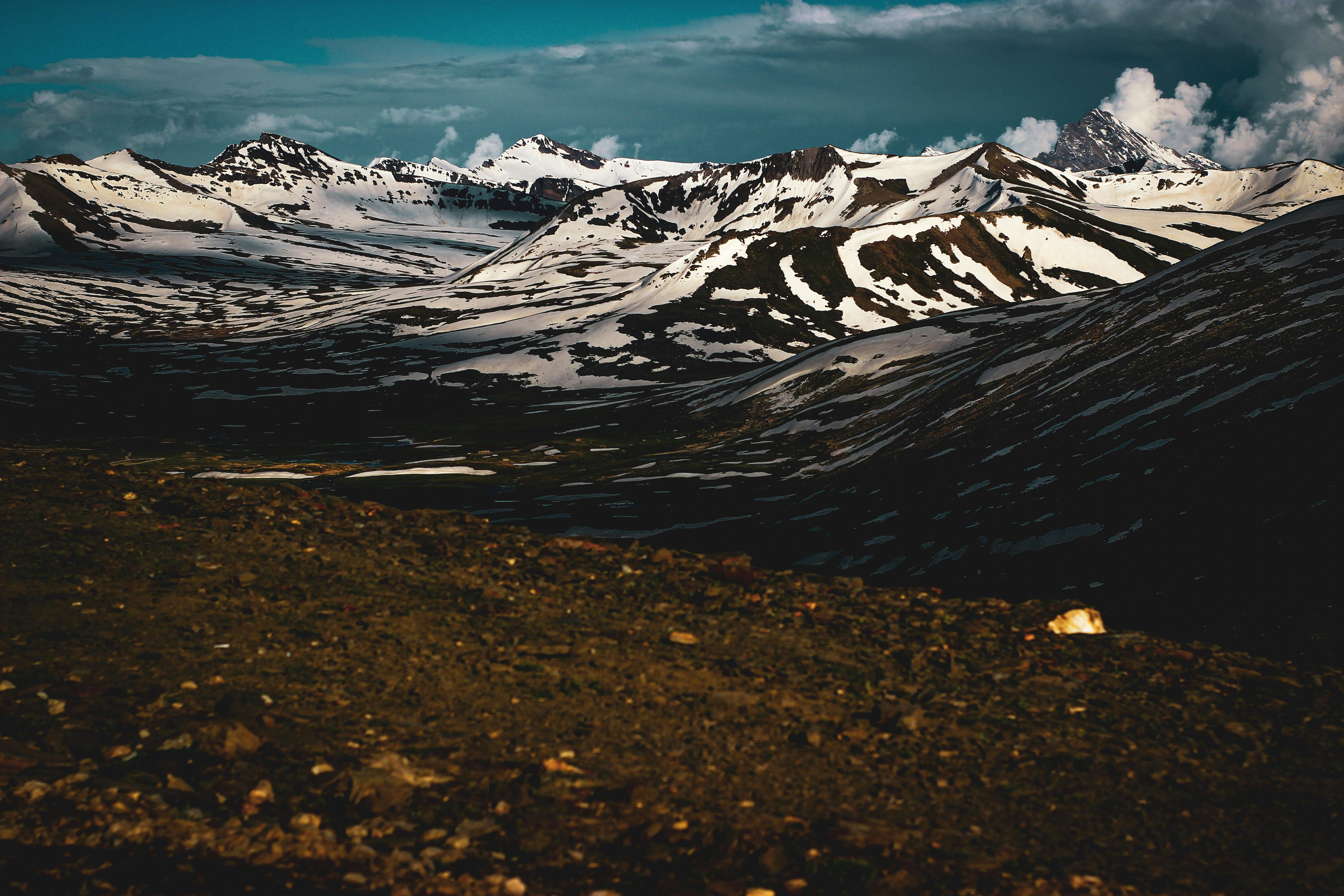 Grass Field Between Two Mountains · Free Stock Photo