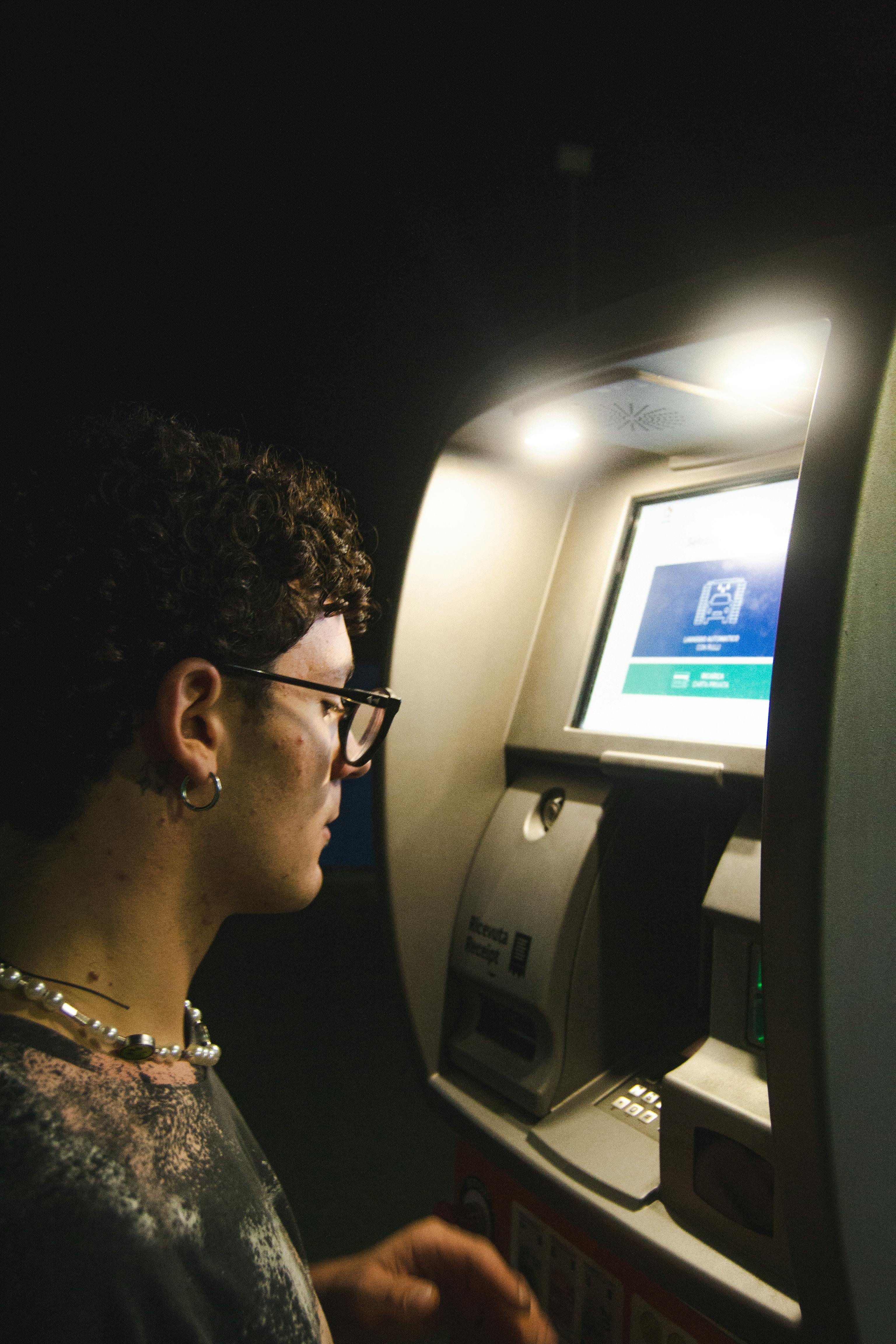 Man Using ATM Machine at Night · Free Stock Photo
