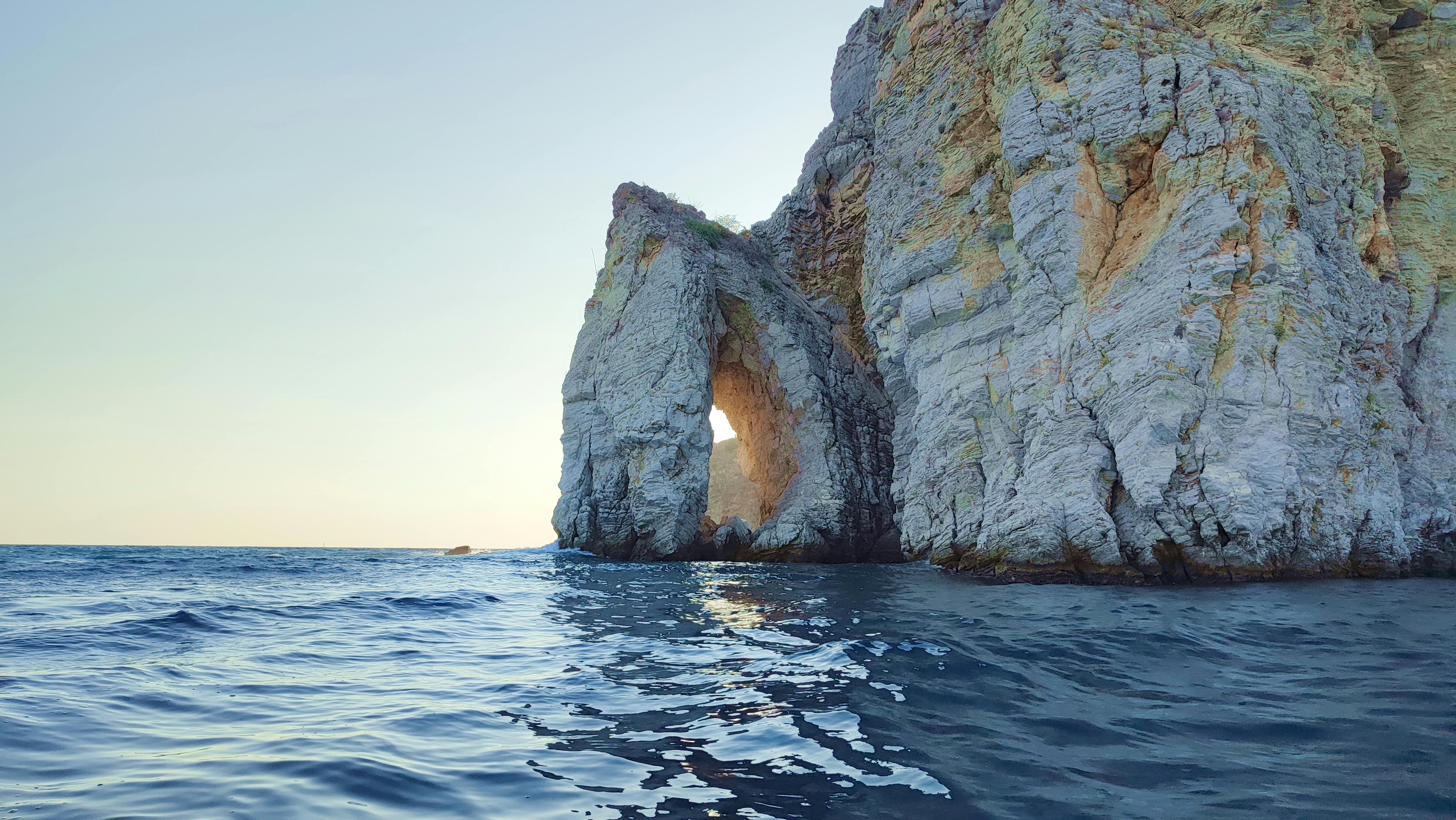 Rock Formation with Arch on Sea · Free Stock Photo