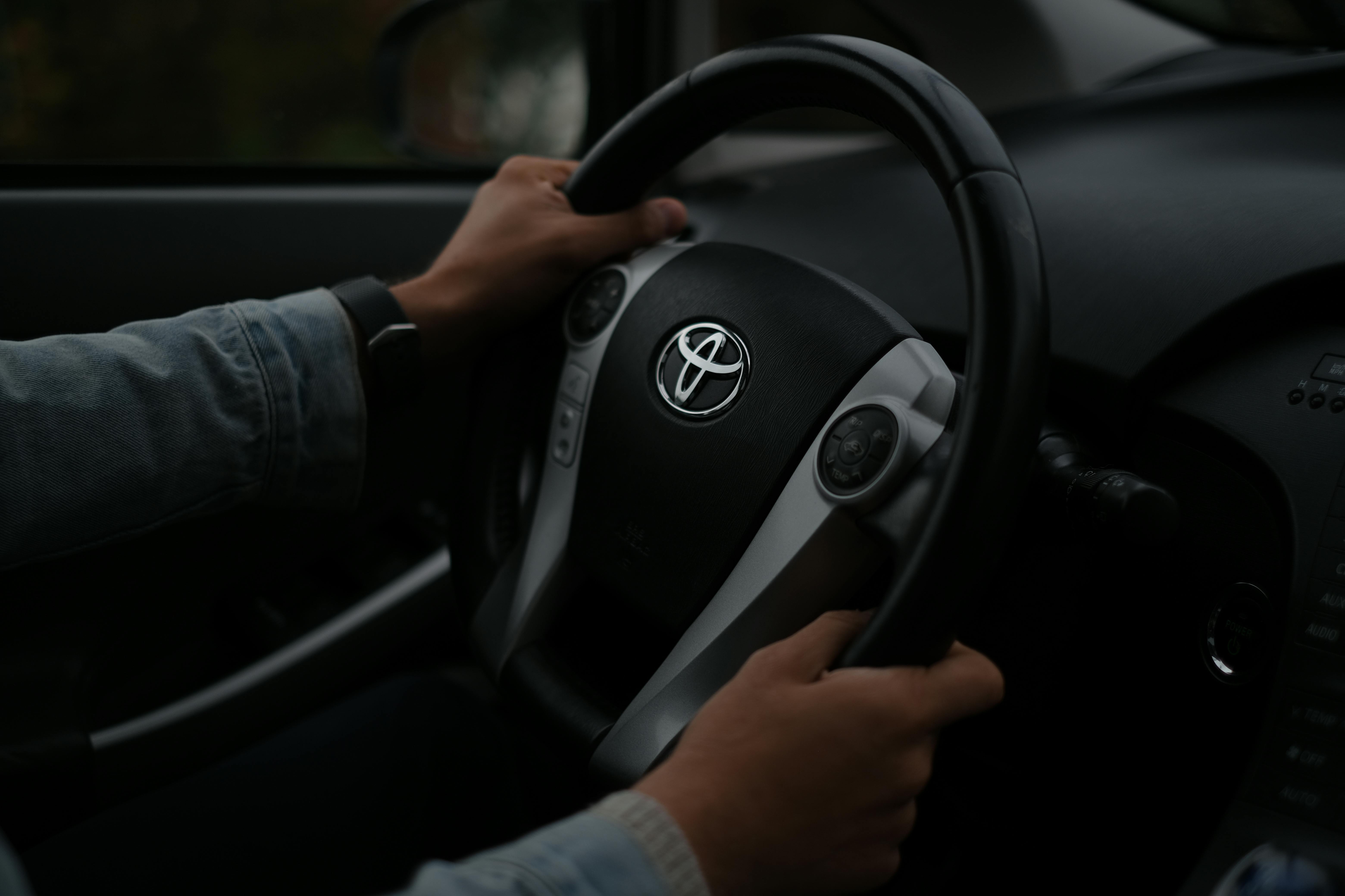A Person Driving a Toyota Car · Free Stock Photo