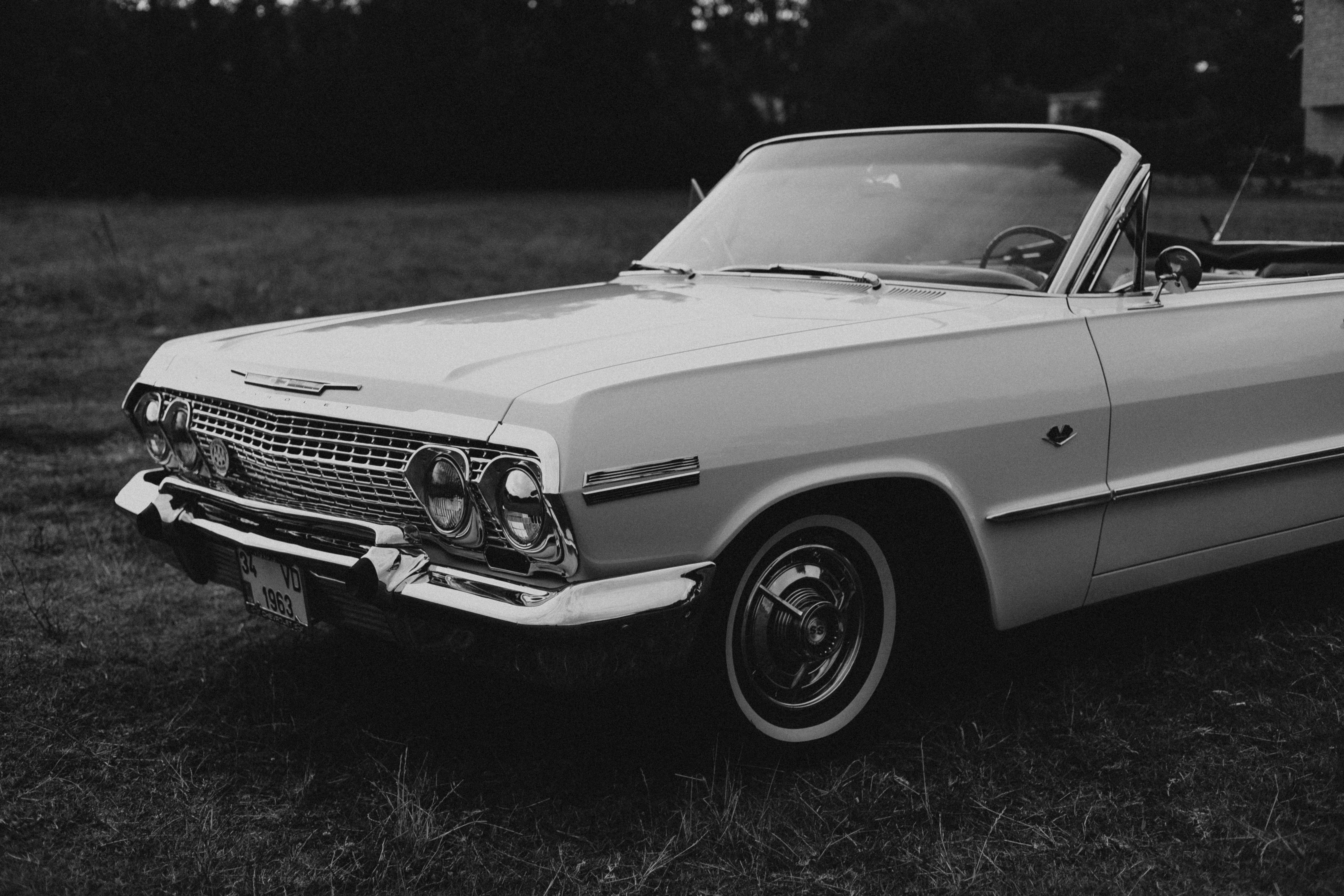 Grayscale Photo of a Classic Car on the Grass · Free Stock Photo