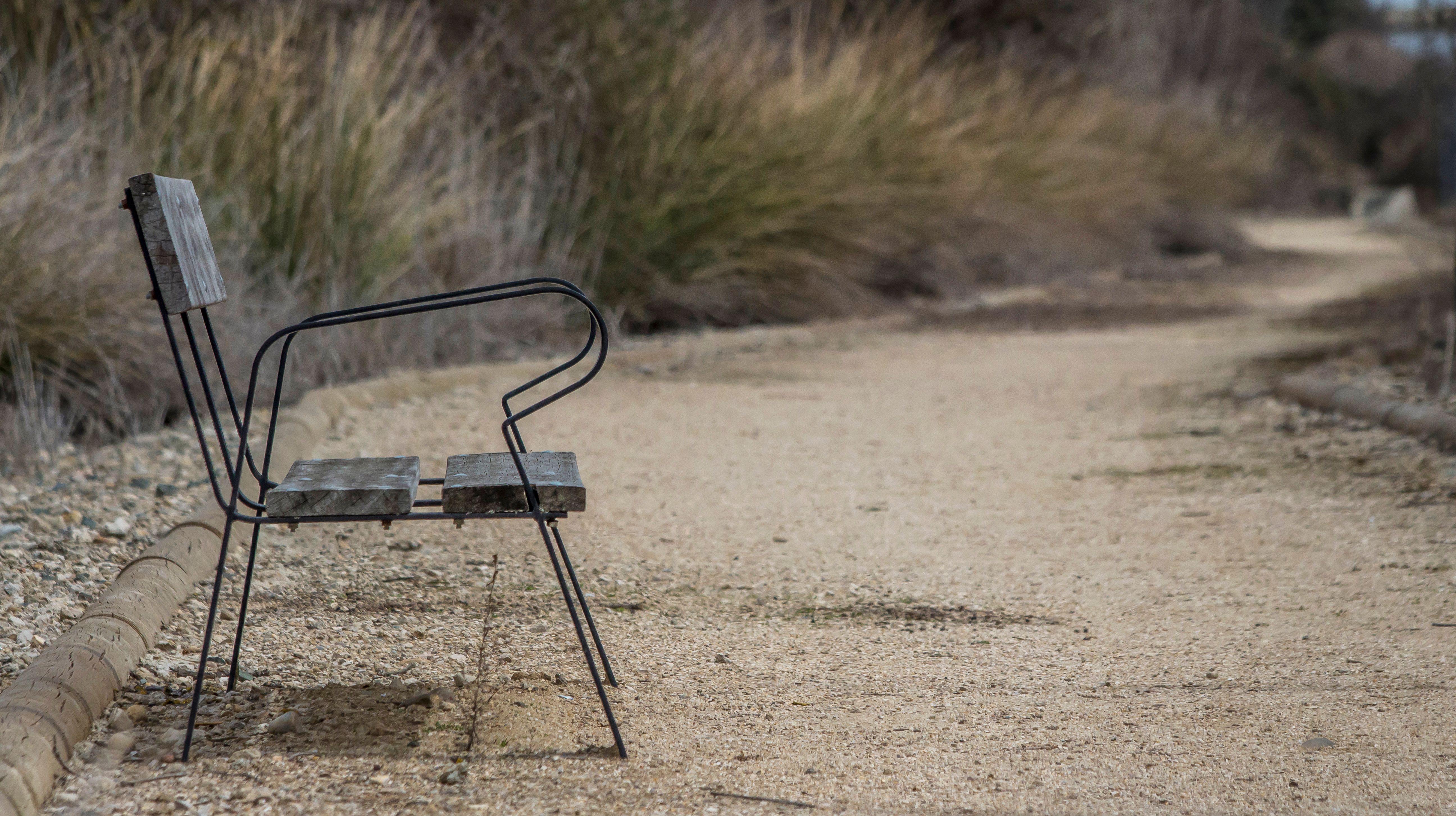 Black Metal Chair on Brown Dirt Road · Free Stock Photo