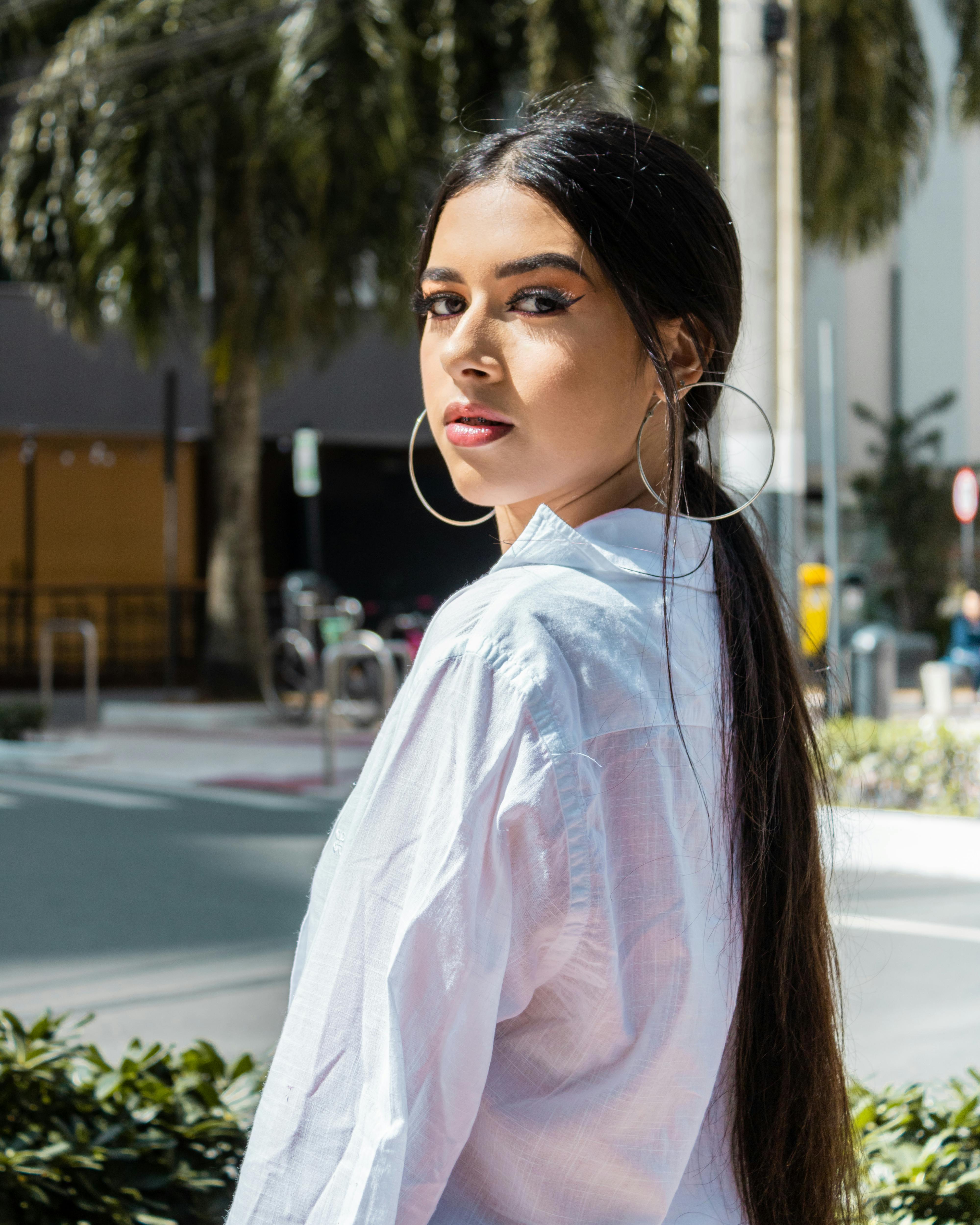 Woman with Hoop Earrings Smiling · Free Stock Photo