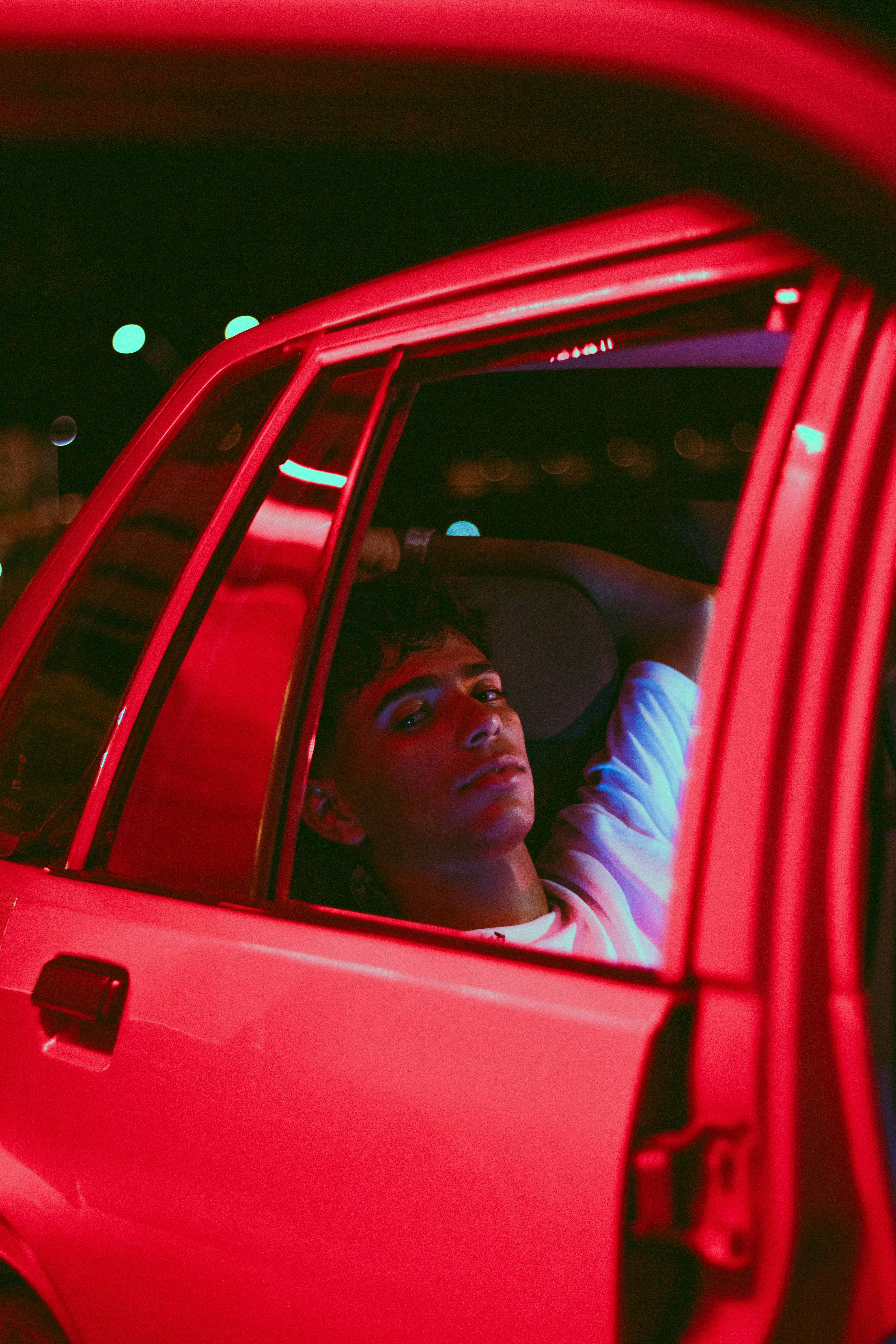 A Man Sitting Inside the Red Car · Free Stock Photo