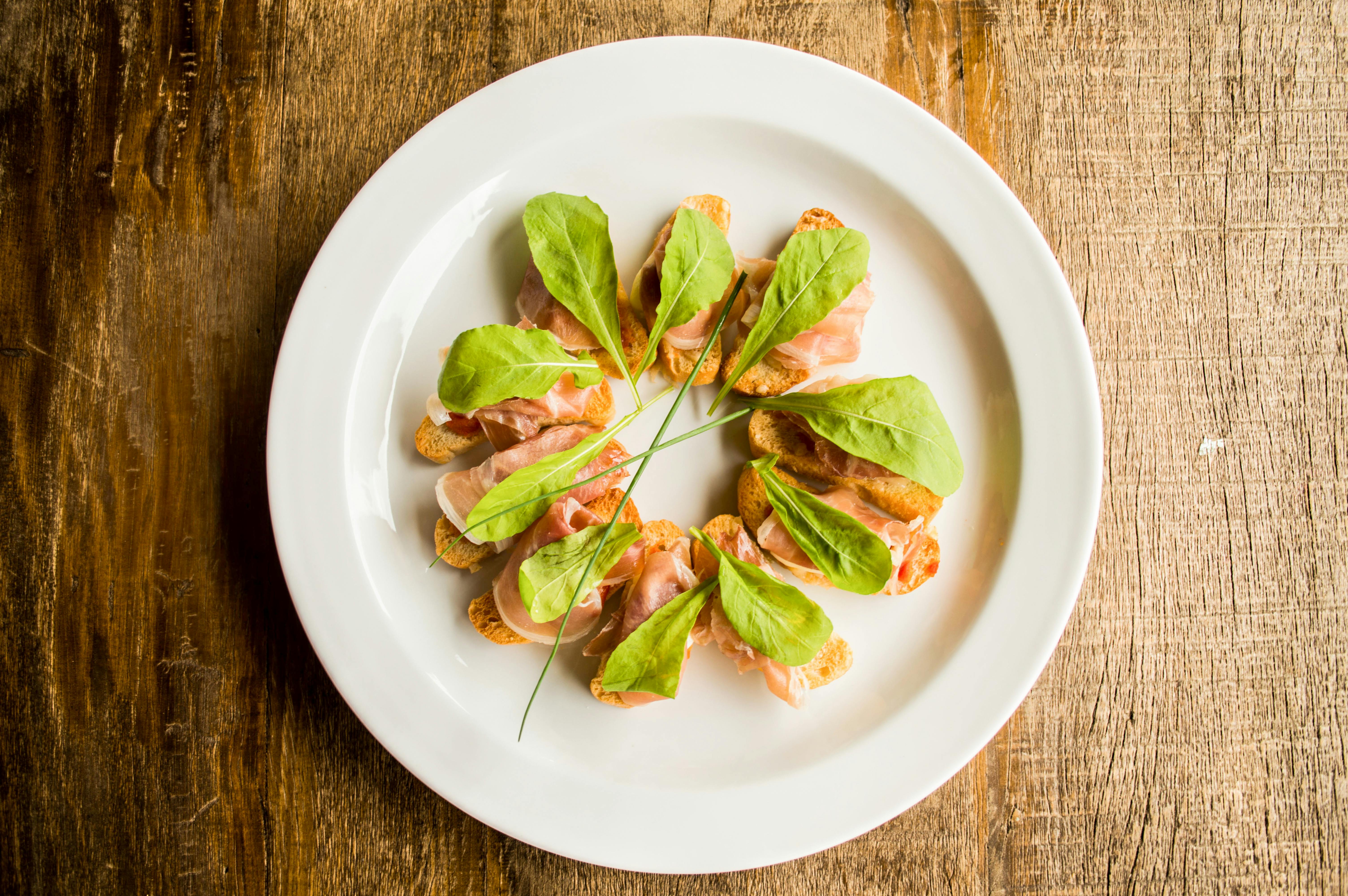 Food with Green Leaves Toppings on a Ceramic Plate · Free Stock Photo