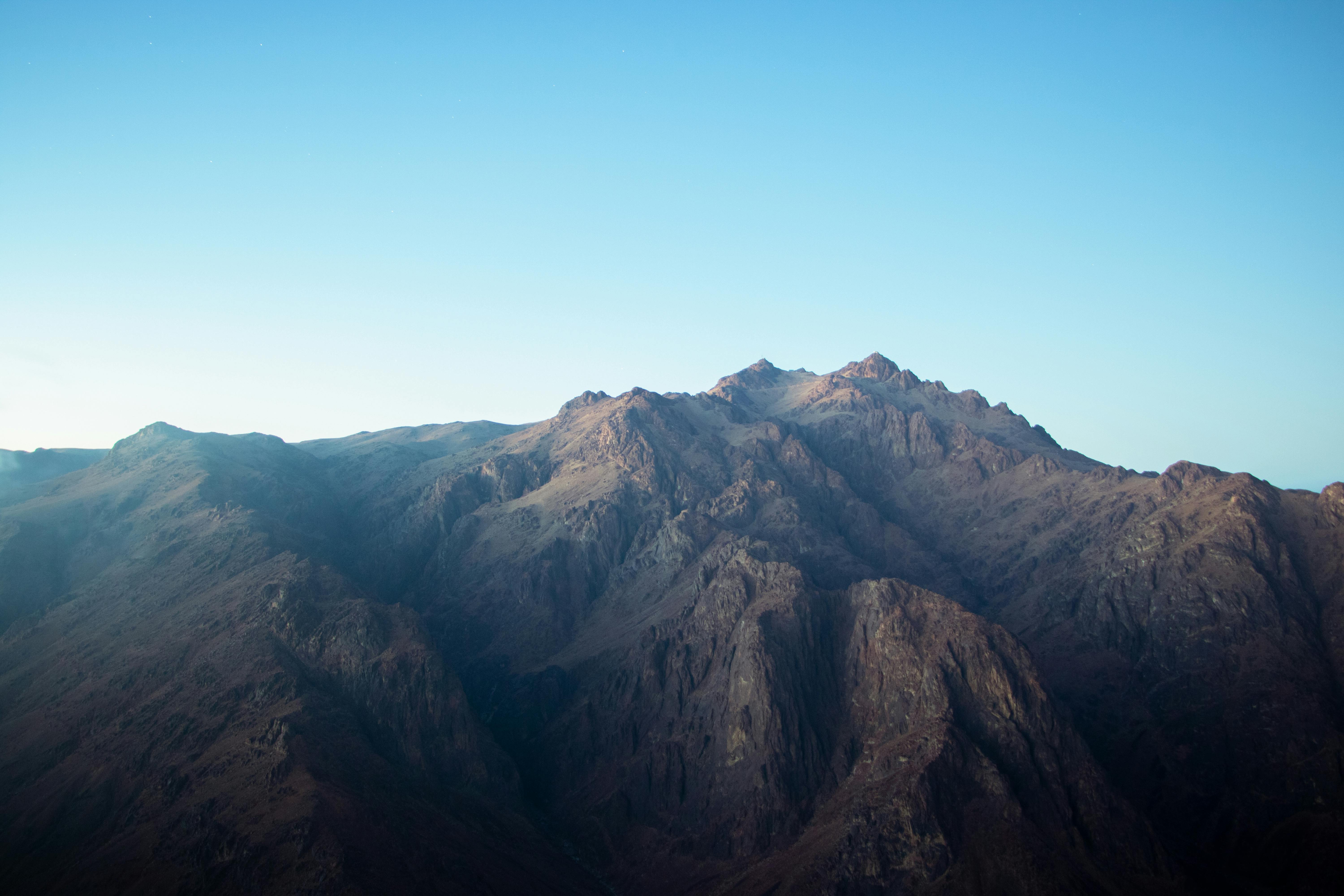 Aerial Photography of Brown Mountains under the Blue Sky · Free Stock Photo