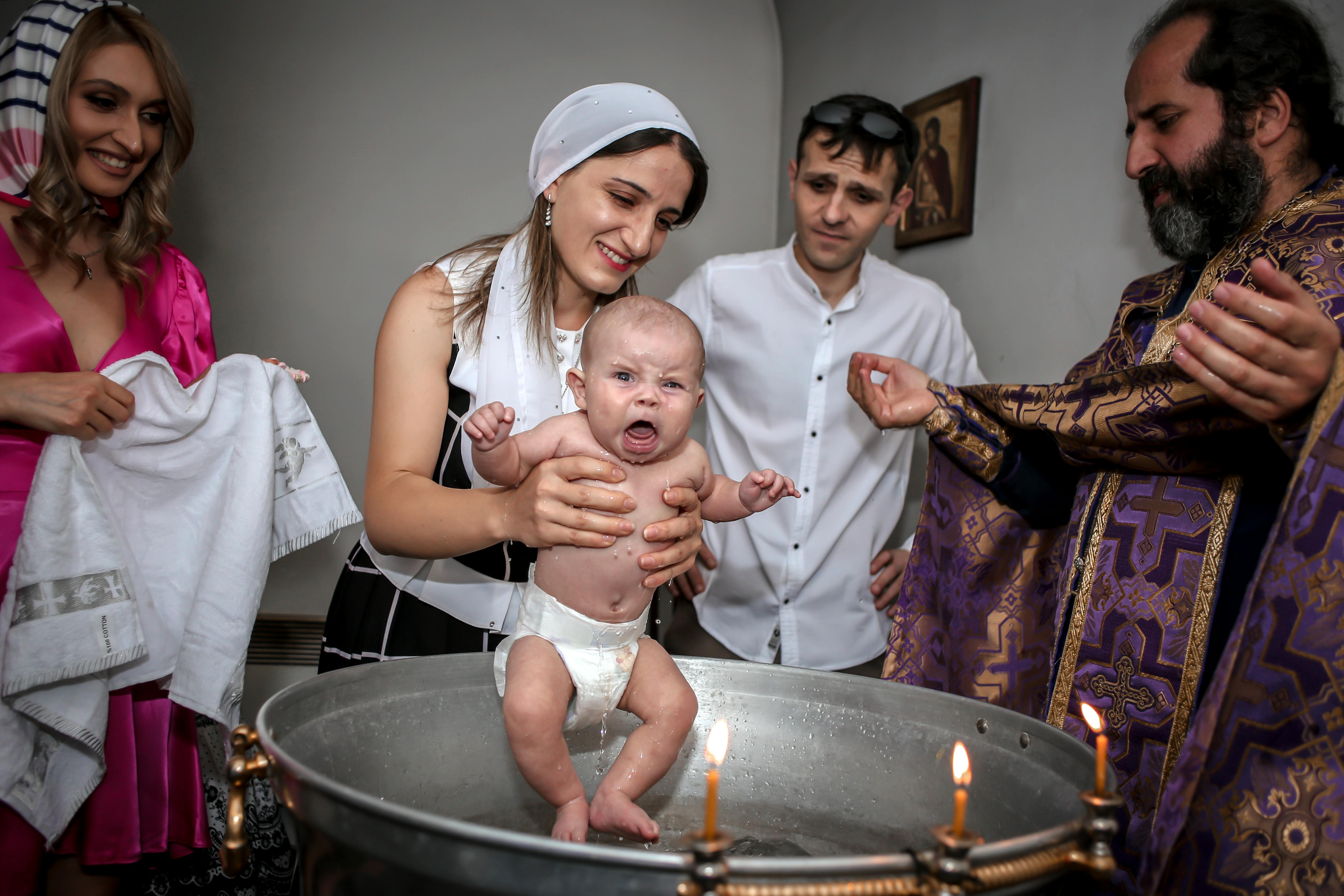 Orthodox Christian Priest Baptizing a Baby · Free Stock Photo