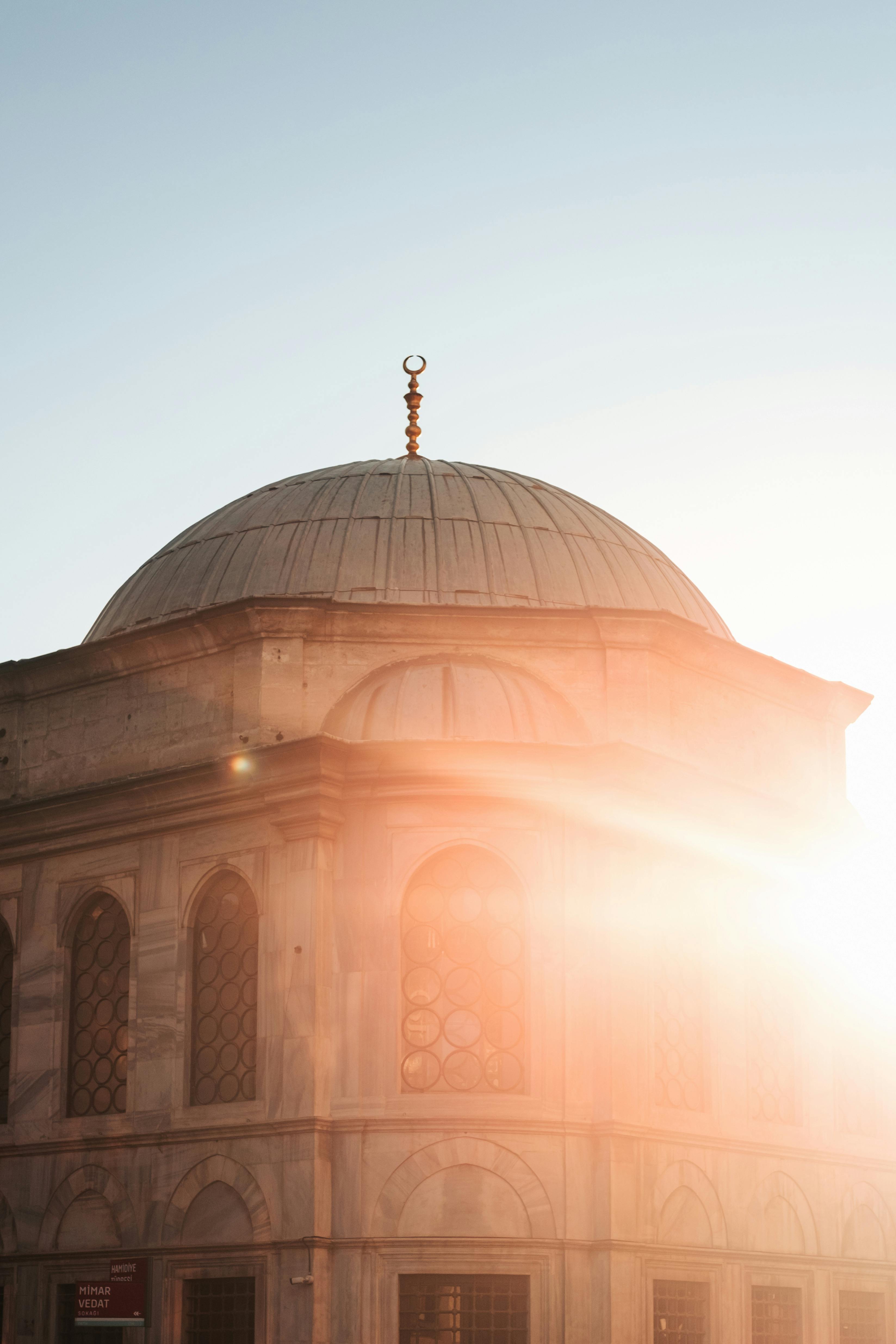Sunlight Behind a Concrete Building with Dome Roof · Free Stock Photo