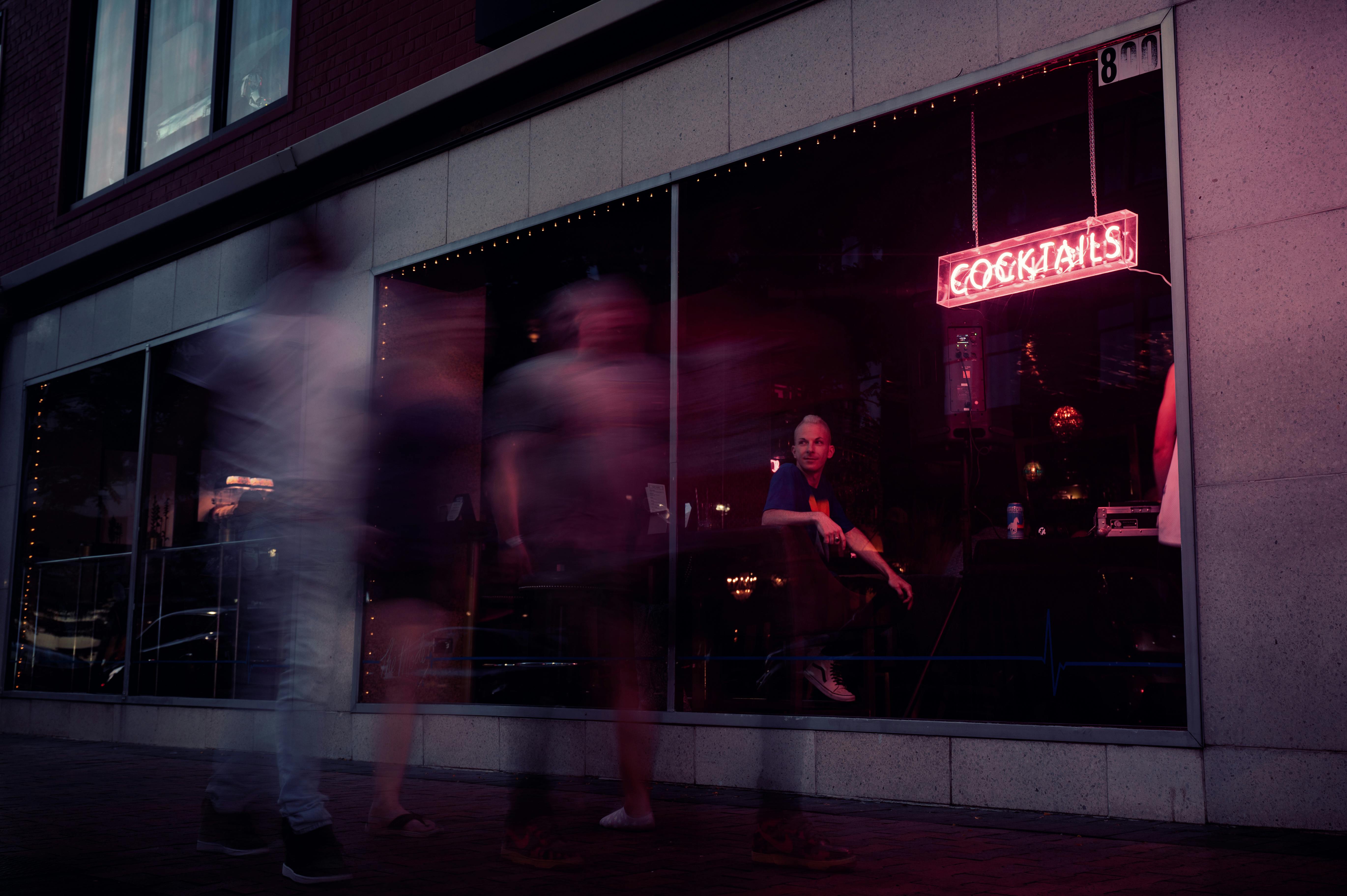 Photo of People Walking by a Bar · Free Stock Photo