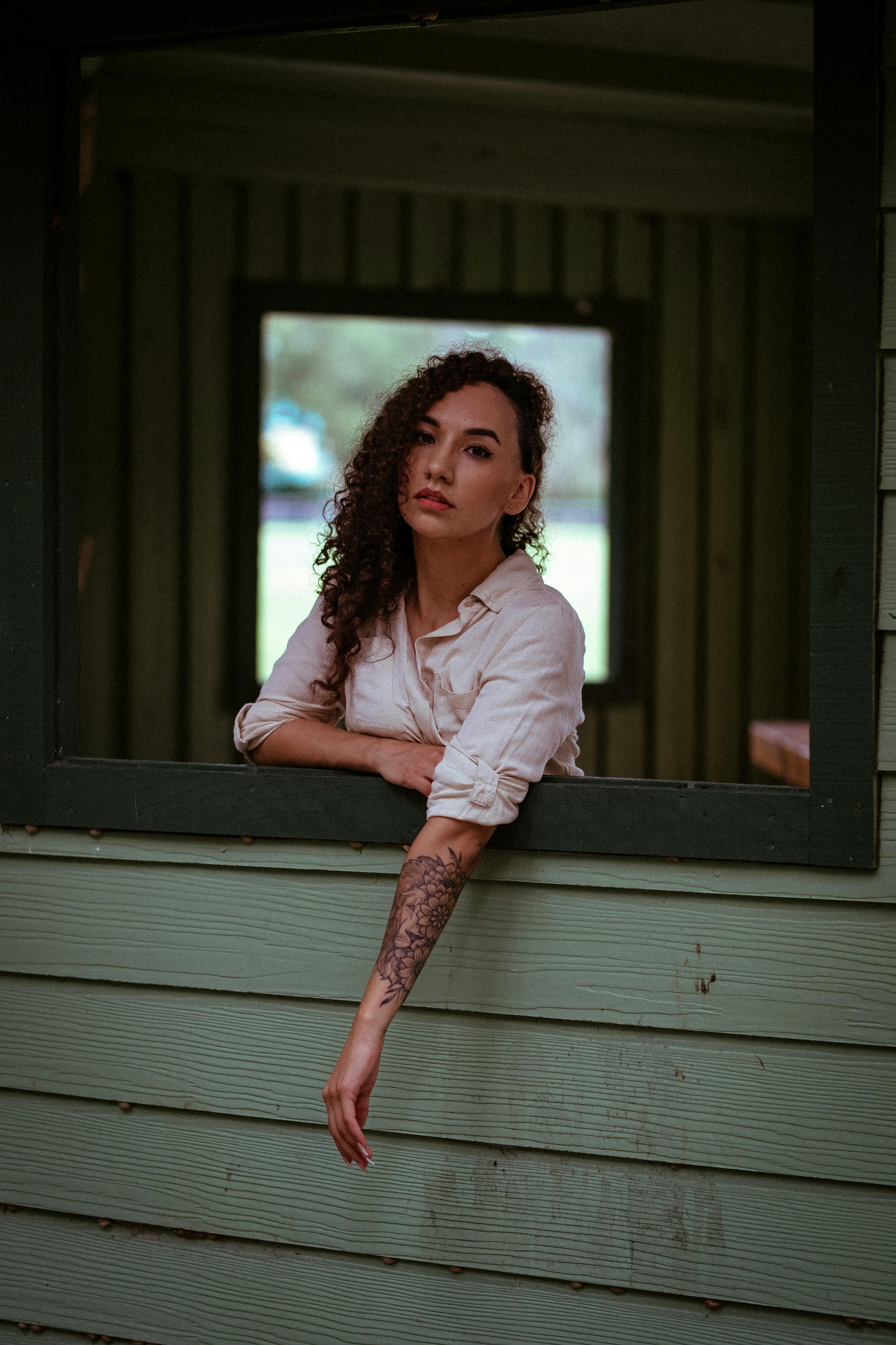 Woman Leaning on Window · Free Stock Photo