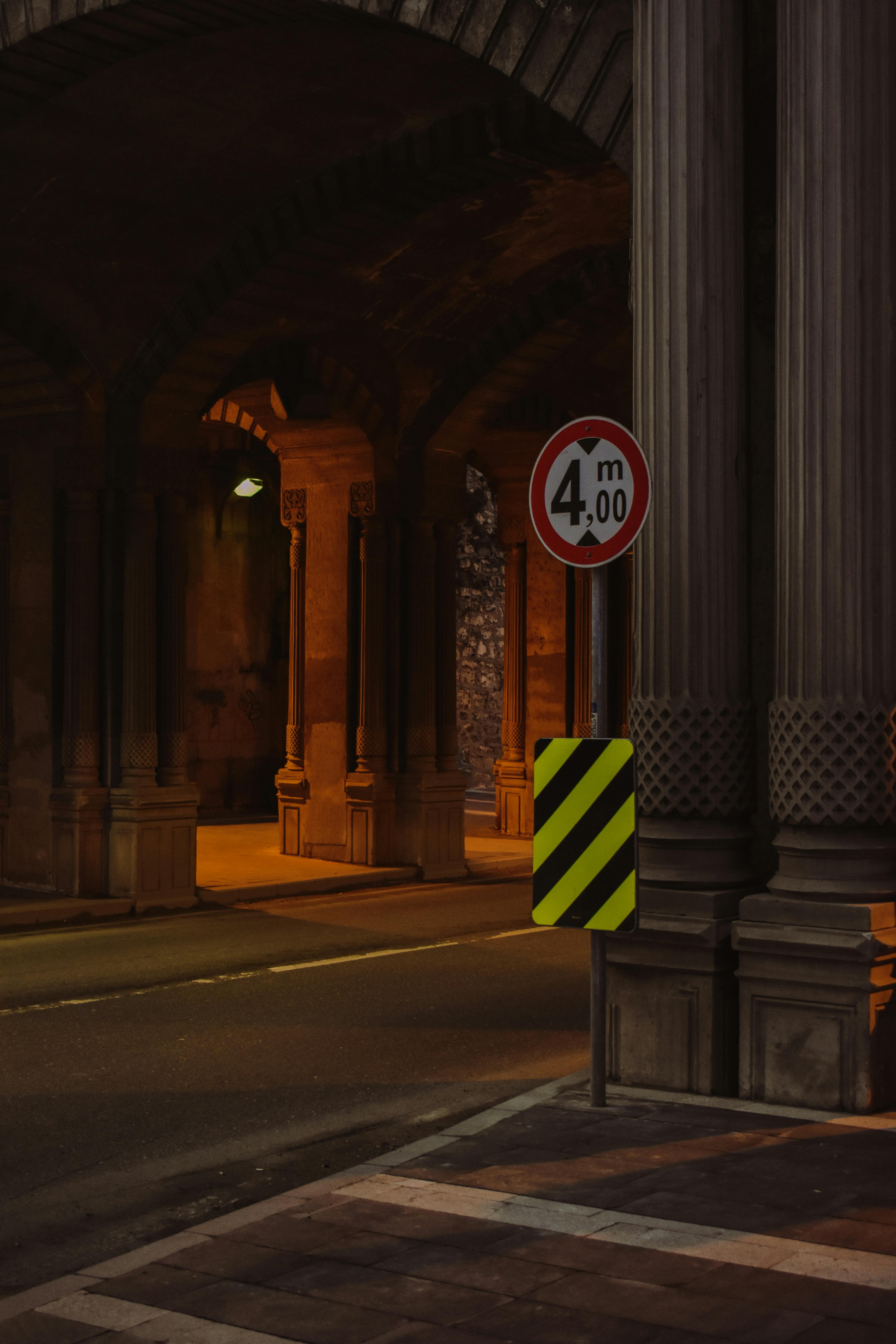 Street Sign Near Concrete Pillars · Free Stock Photo