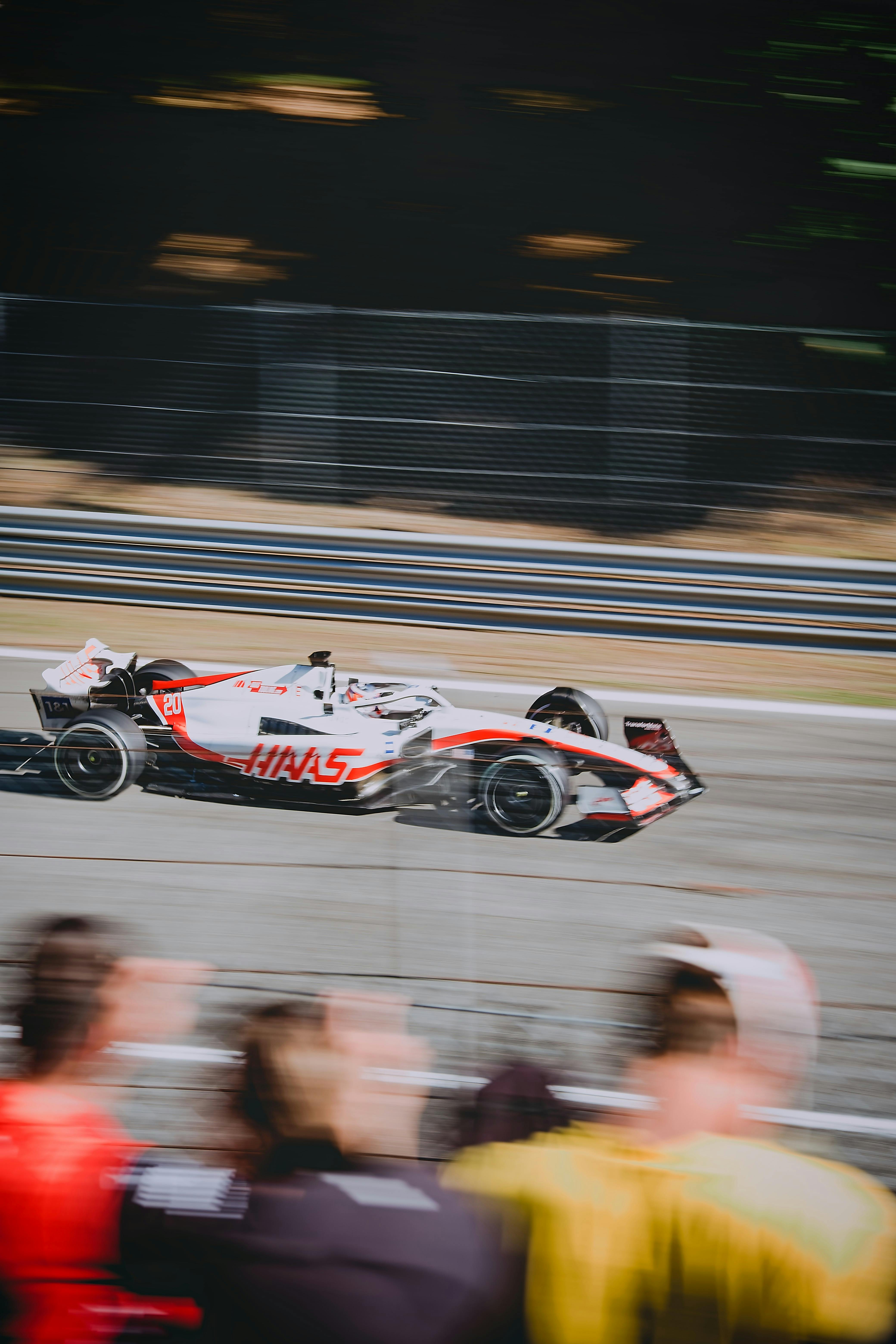 People Watching a Red and White Racing Car on Race Track · Free Stock Photo
