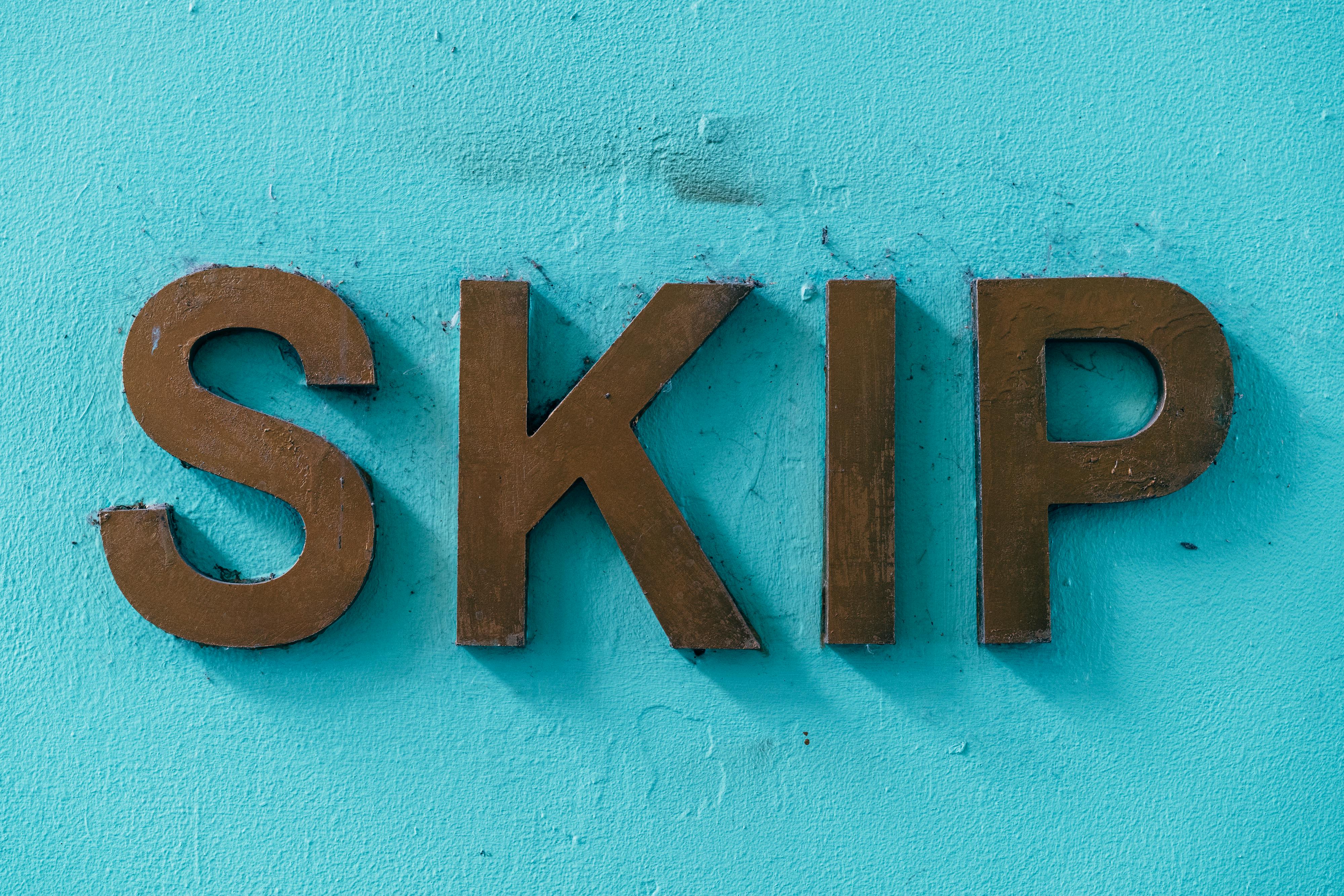 Skip Text on Blue Wall · Free Stock Photo