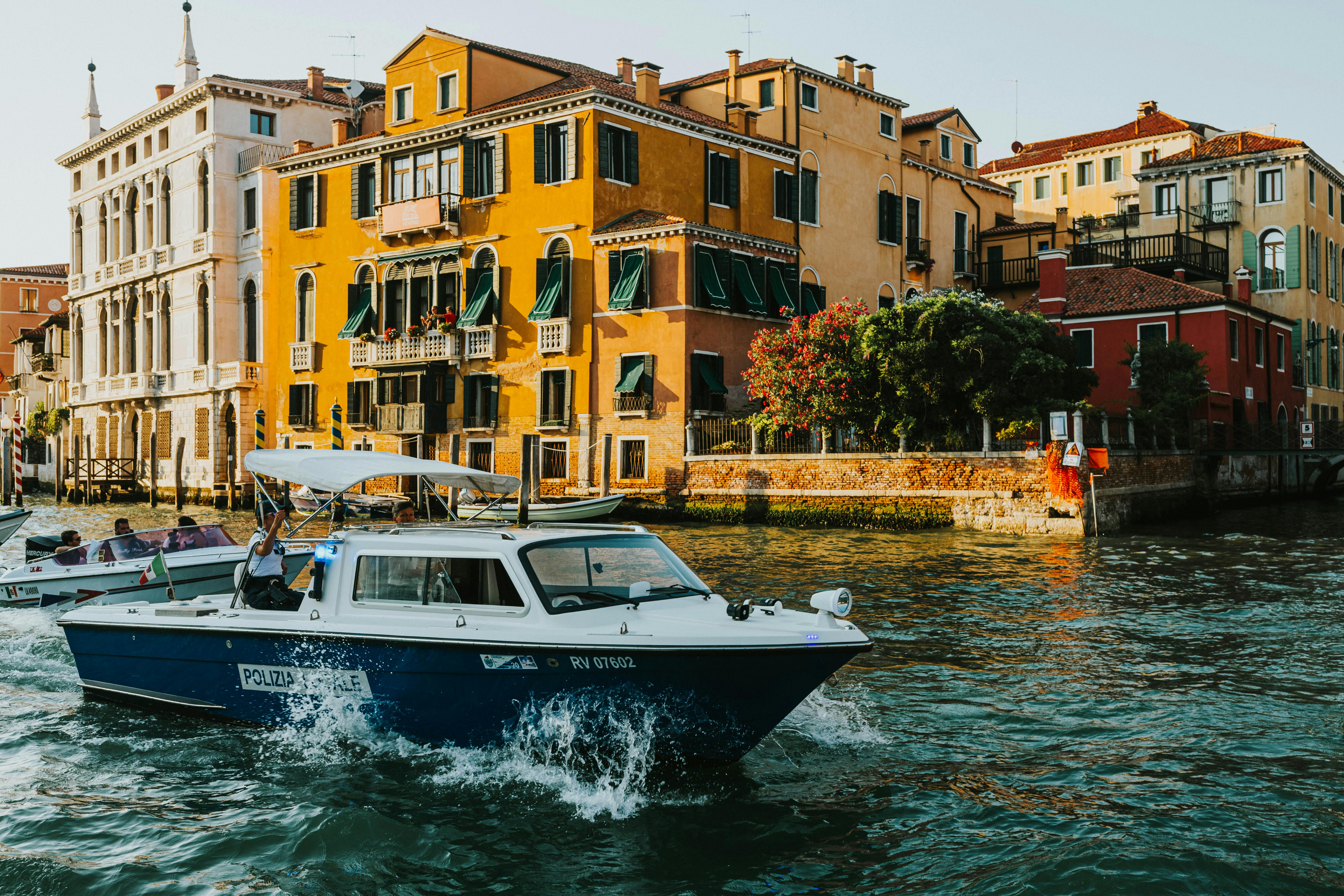 Motorboat on Water Canal in City · Free Stock Photo
