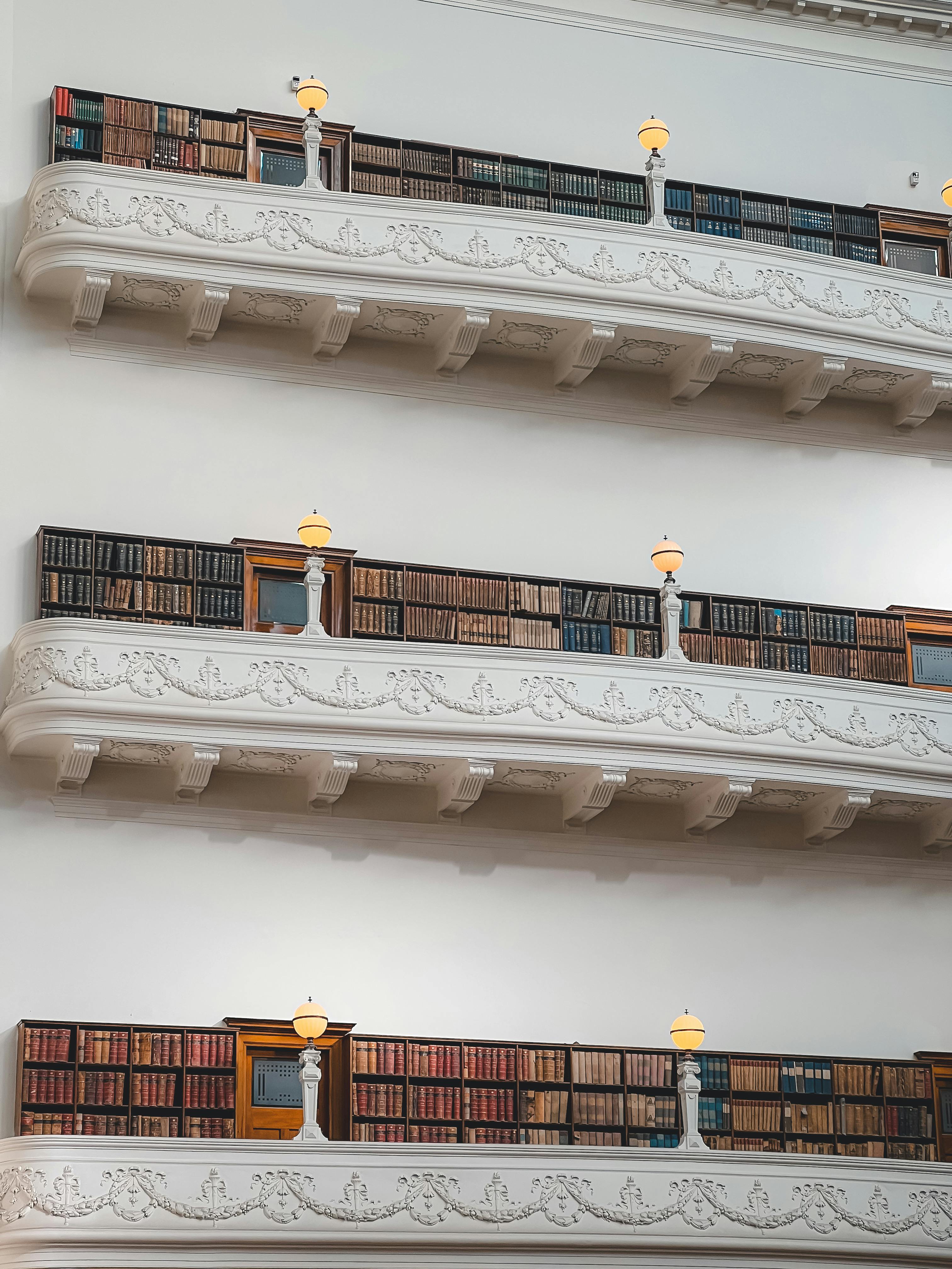 A Mini Library Decor on White Wooden Wall Mounted Shelves · Free Stock ...