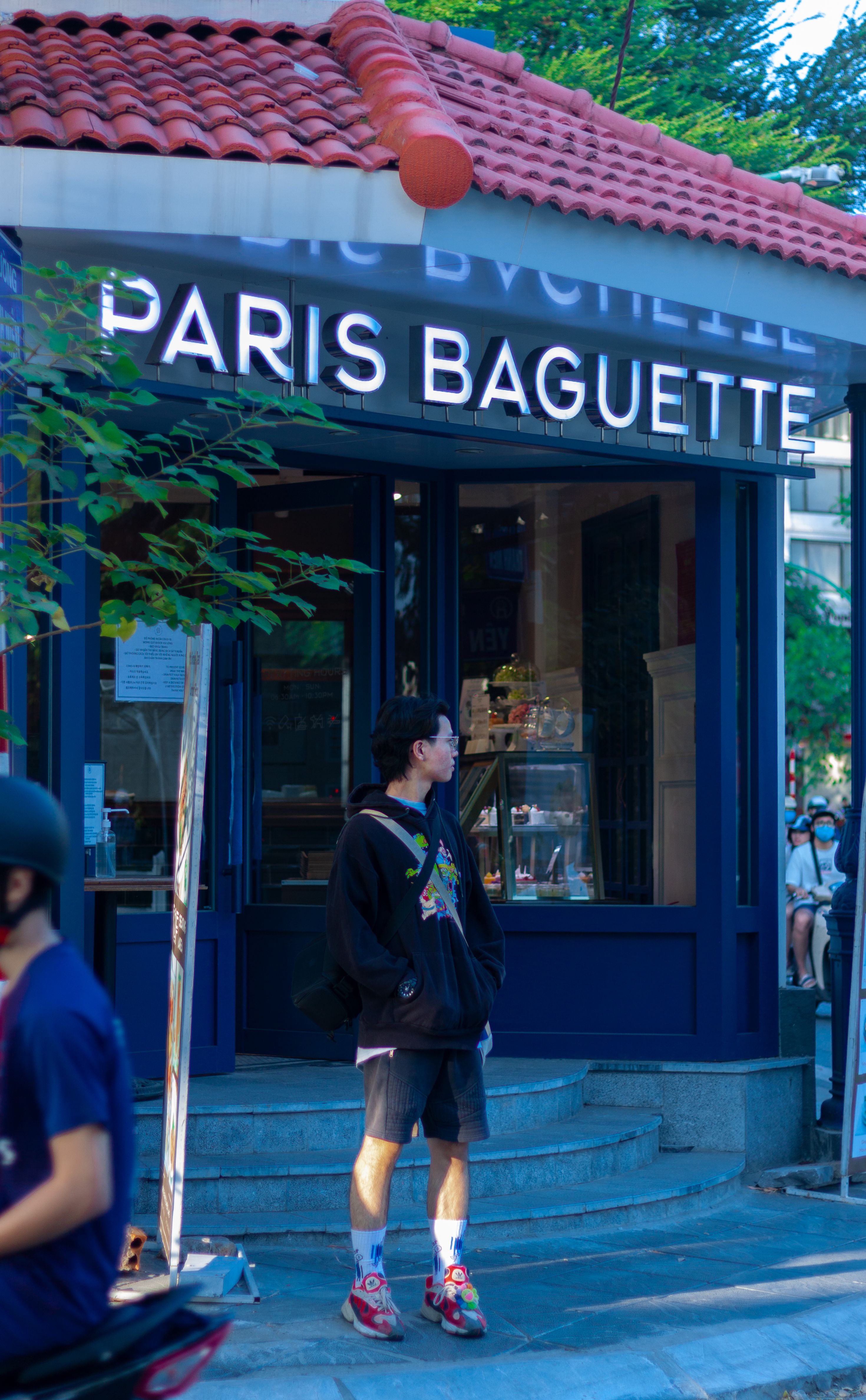 Man Standing in front of Bakery Entrance · Free Stock Photo
