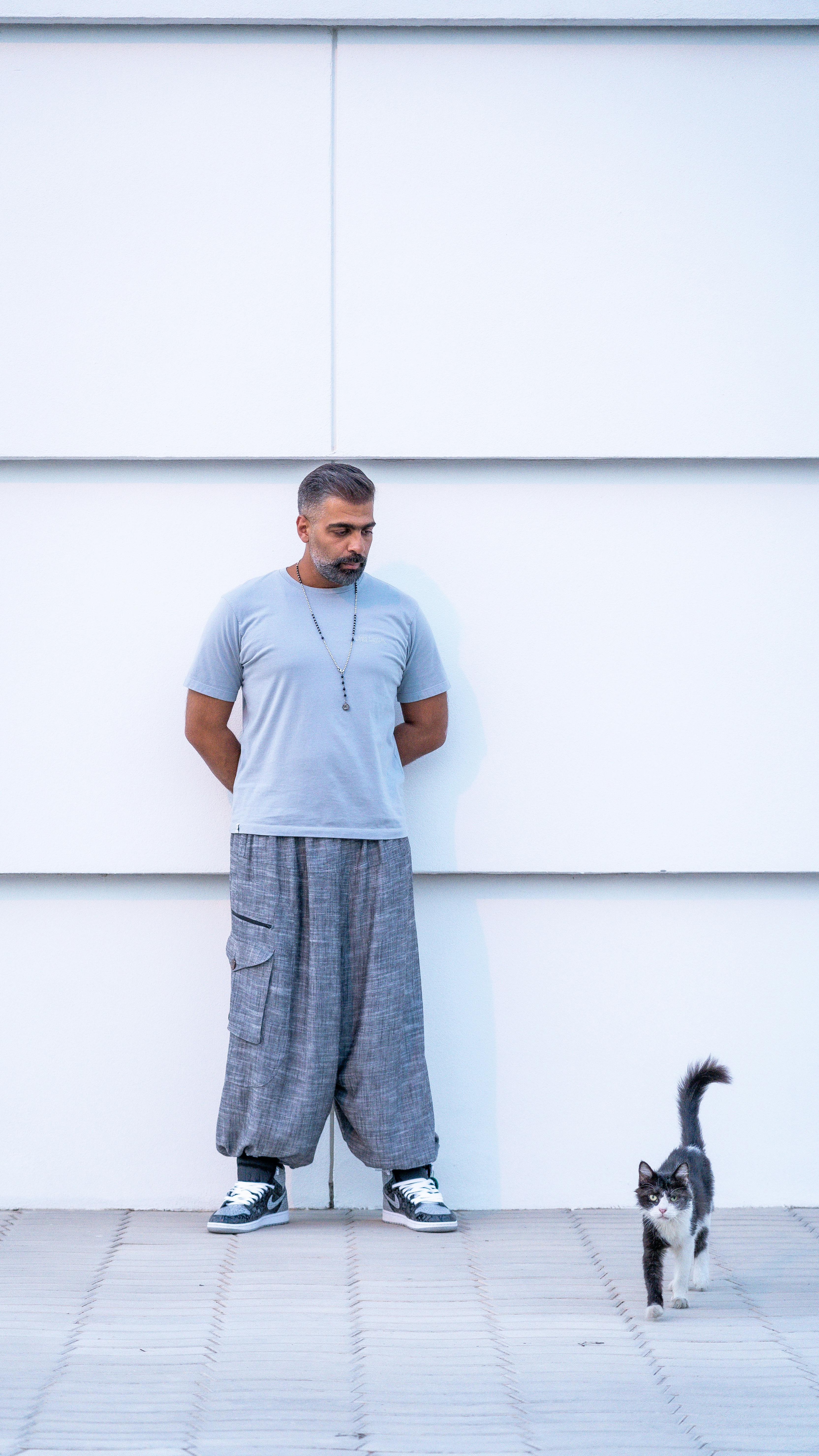 Man Standing and Looking at a Cat · Free Stock Photo