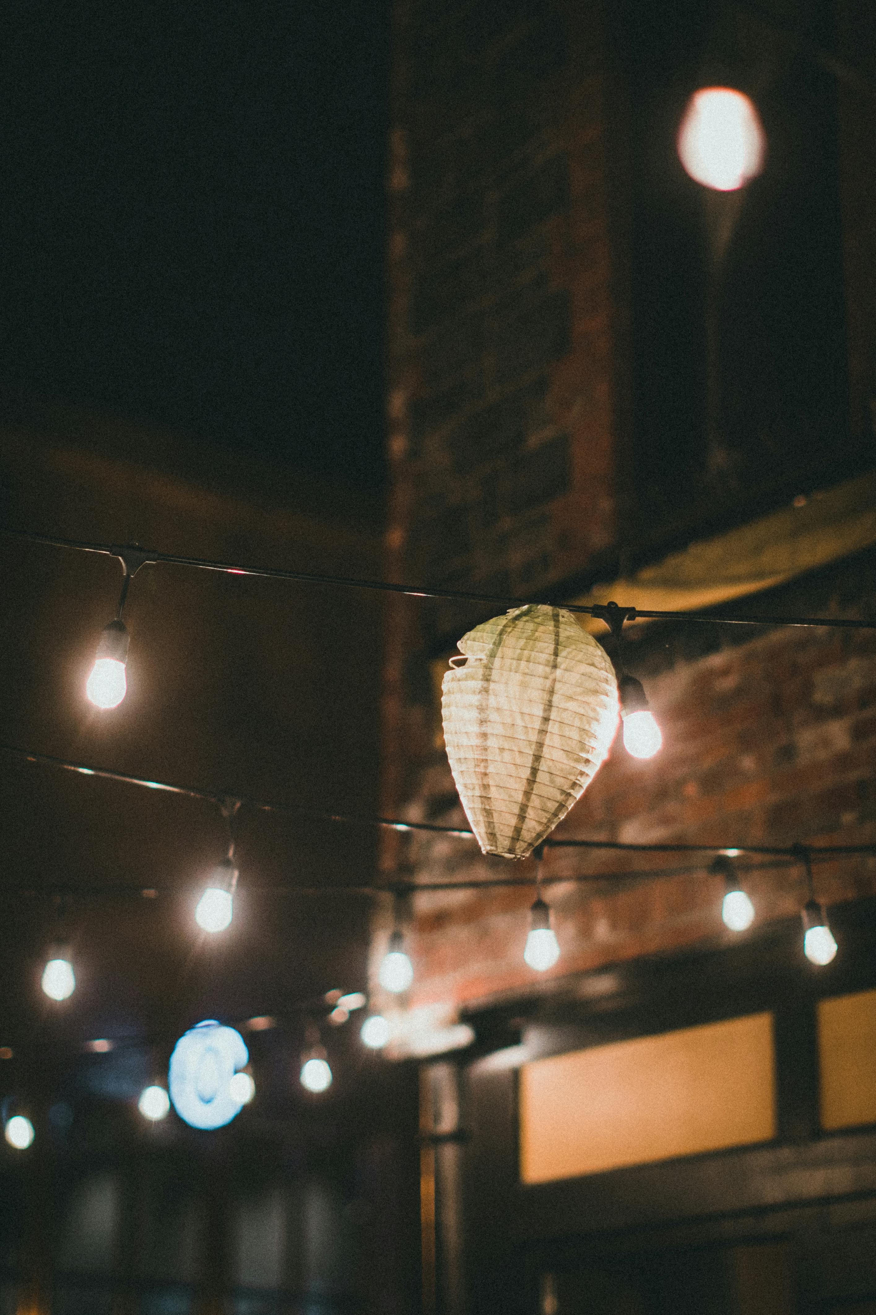 String Lights Near Brick Wall · Free Stock Photo