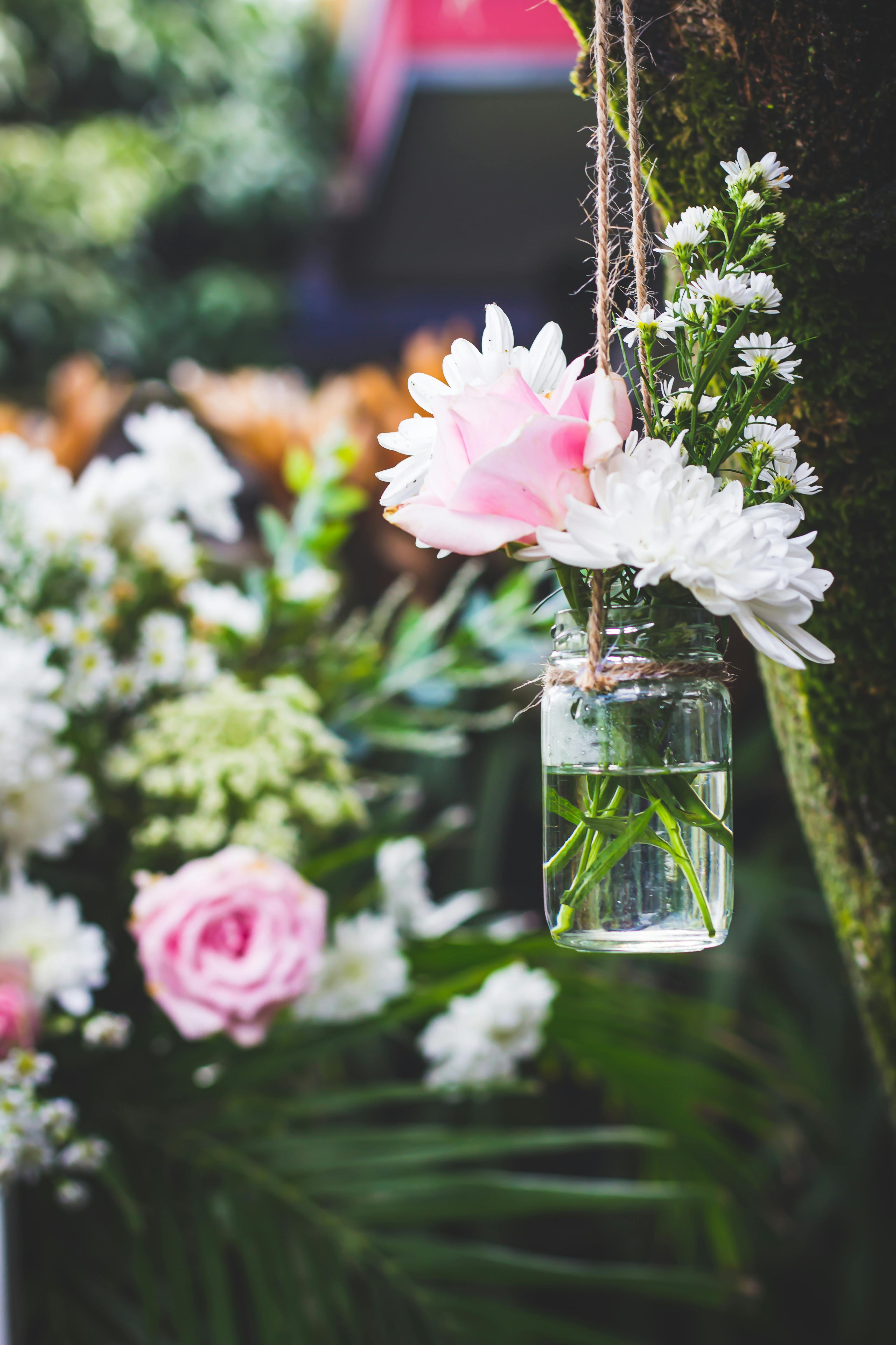 Fresh Flowers on Glass Vase Hanging on a Tree Trunk on the Garden ...