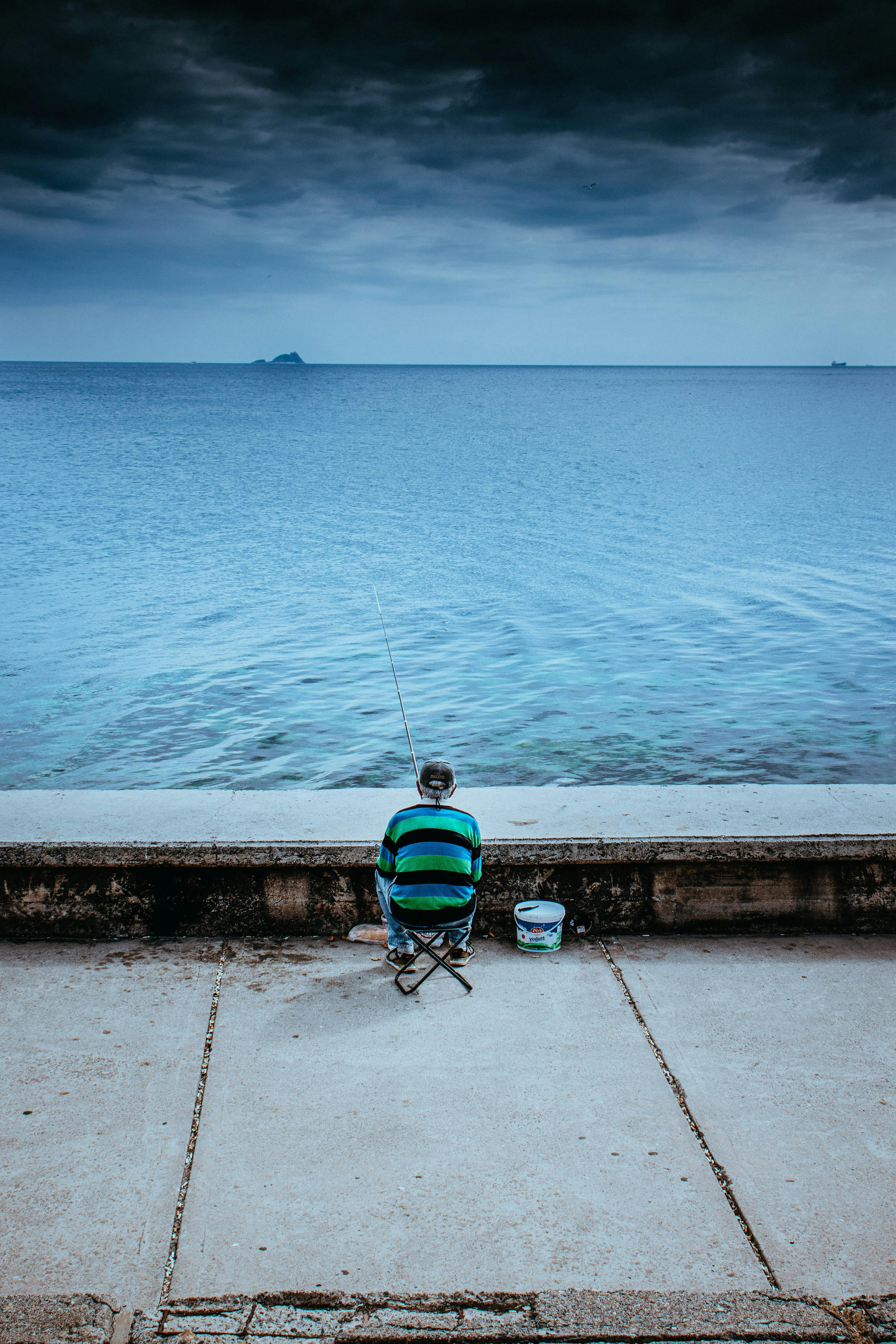 A Man Fishing on the Bay · Free Stock Photo