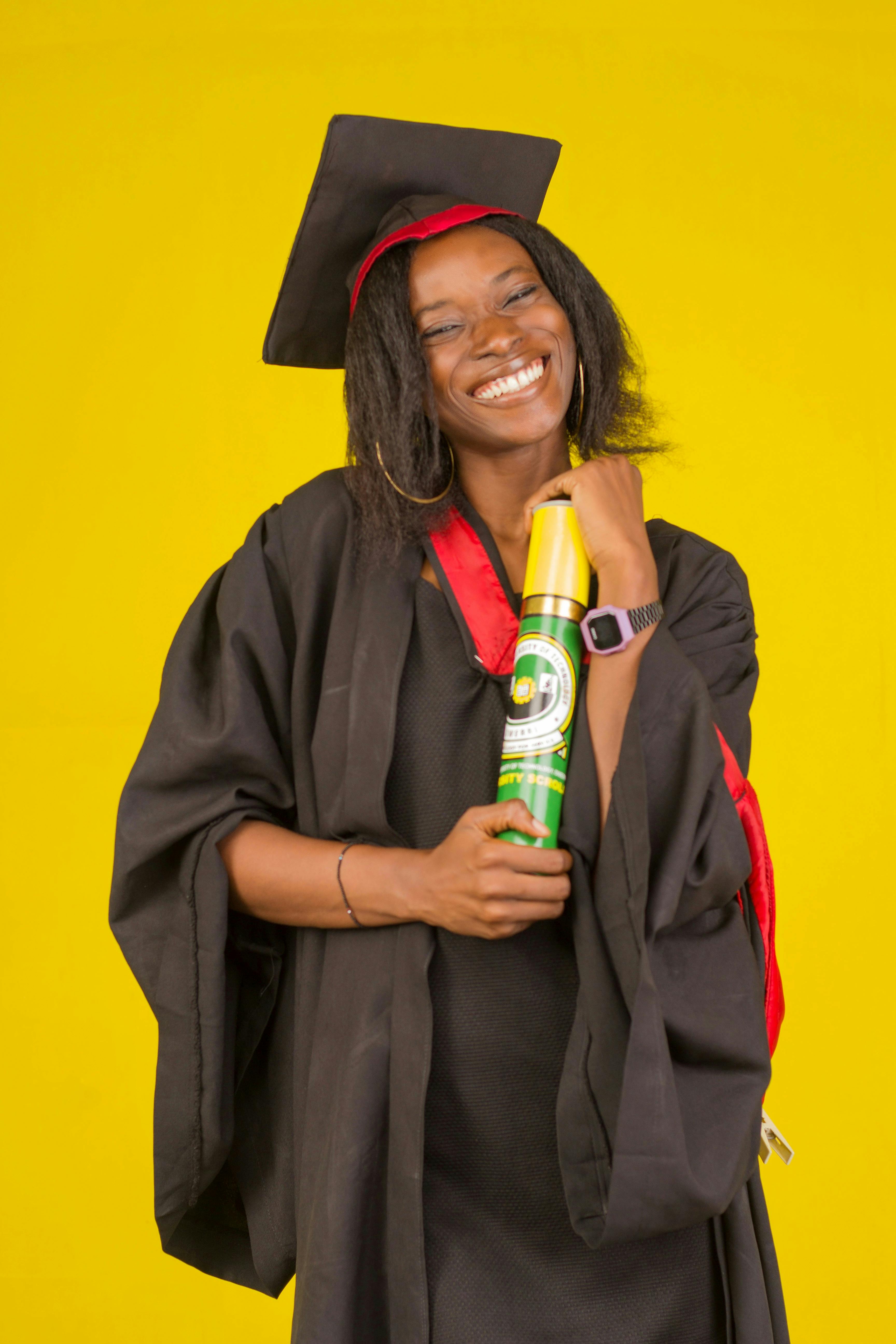 A Freshly Graduate Female Student in Black Academic Dress Smiling ...