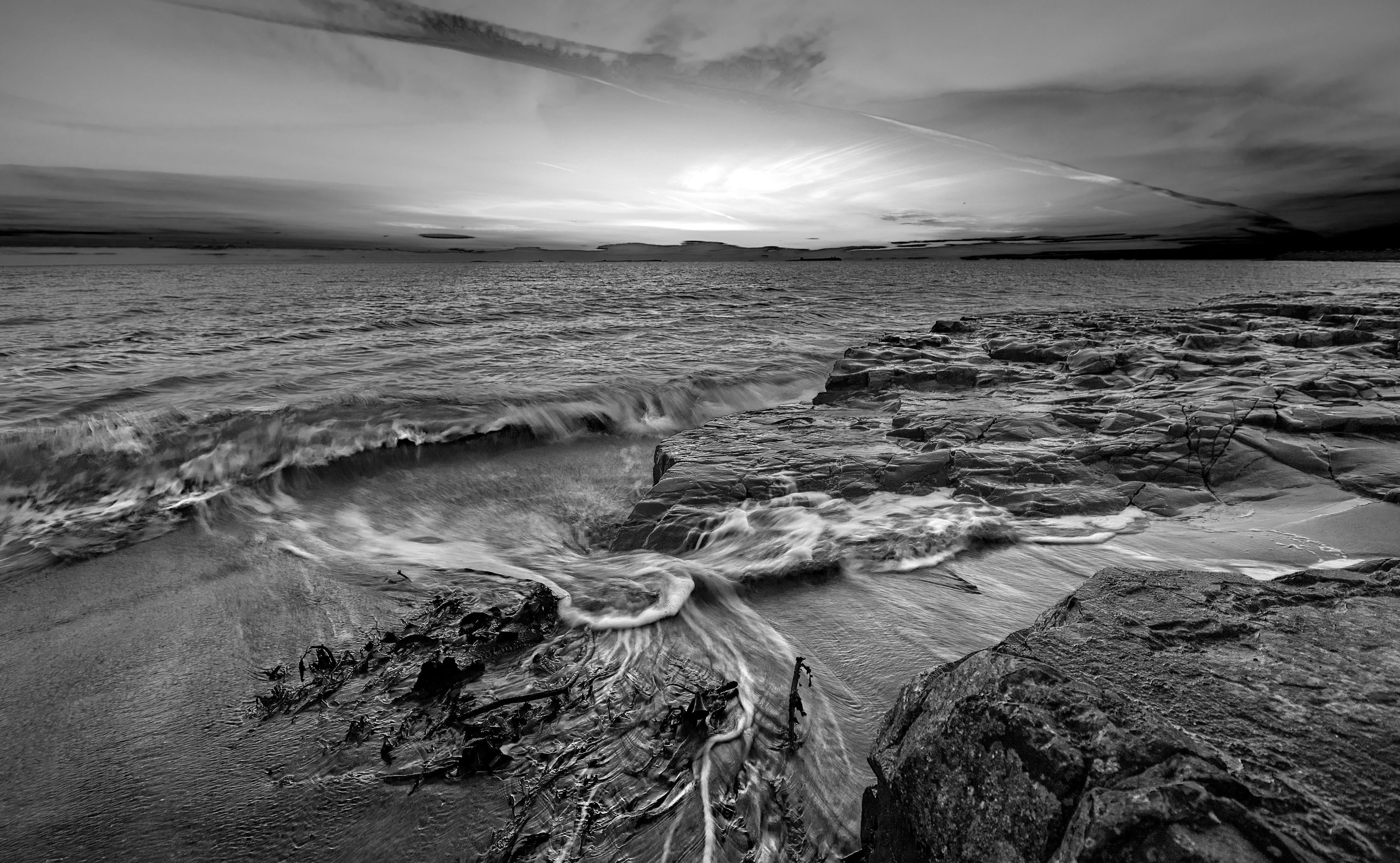 A Grayscale Photo of Beach Waves Crashing on Shore · Free Stock Photo