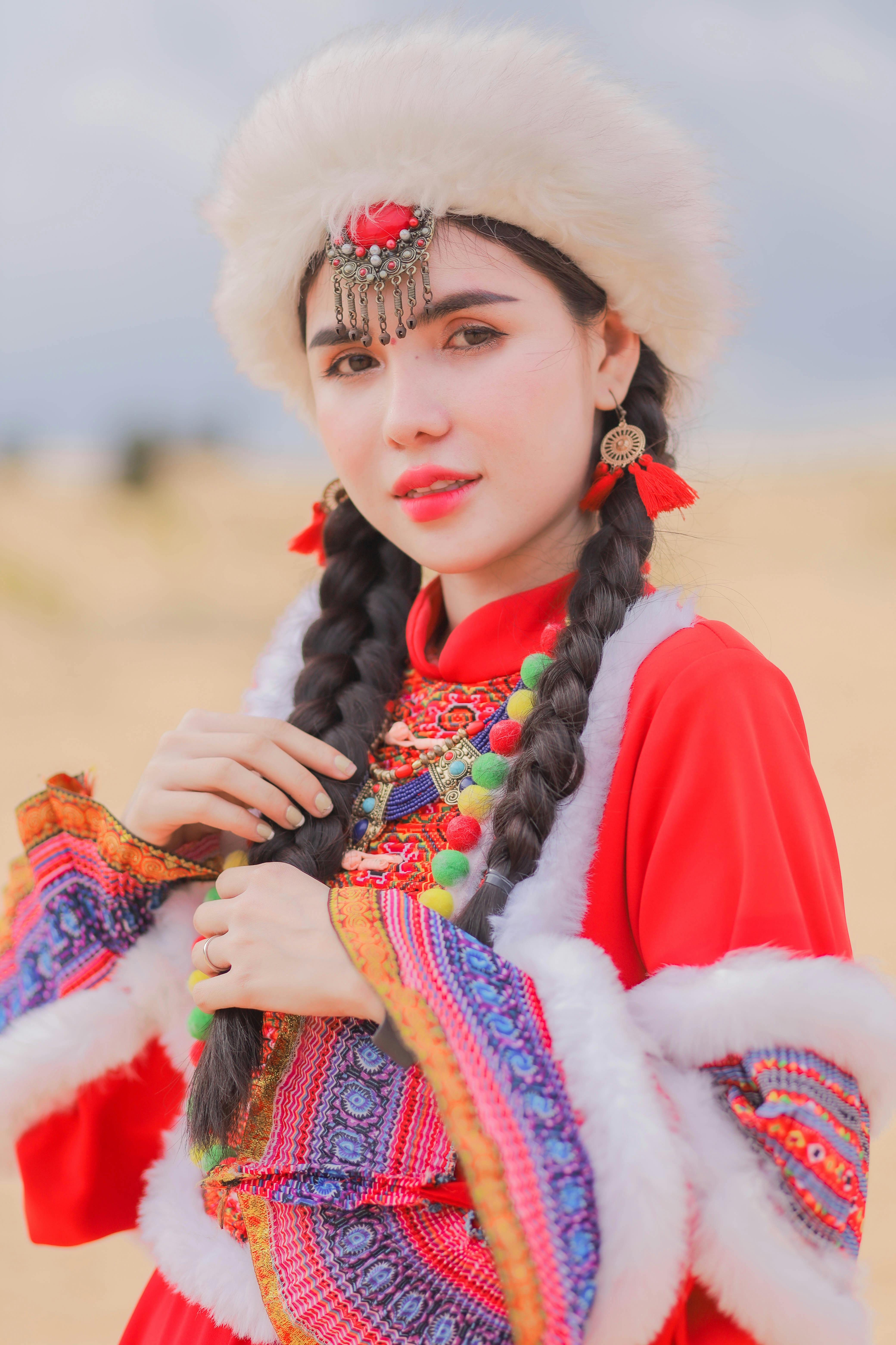 A Woman Wearing Red and White Traditional Costume and White Fur Hat ...