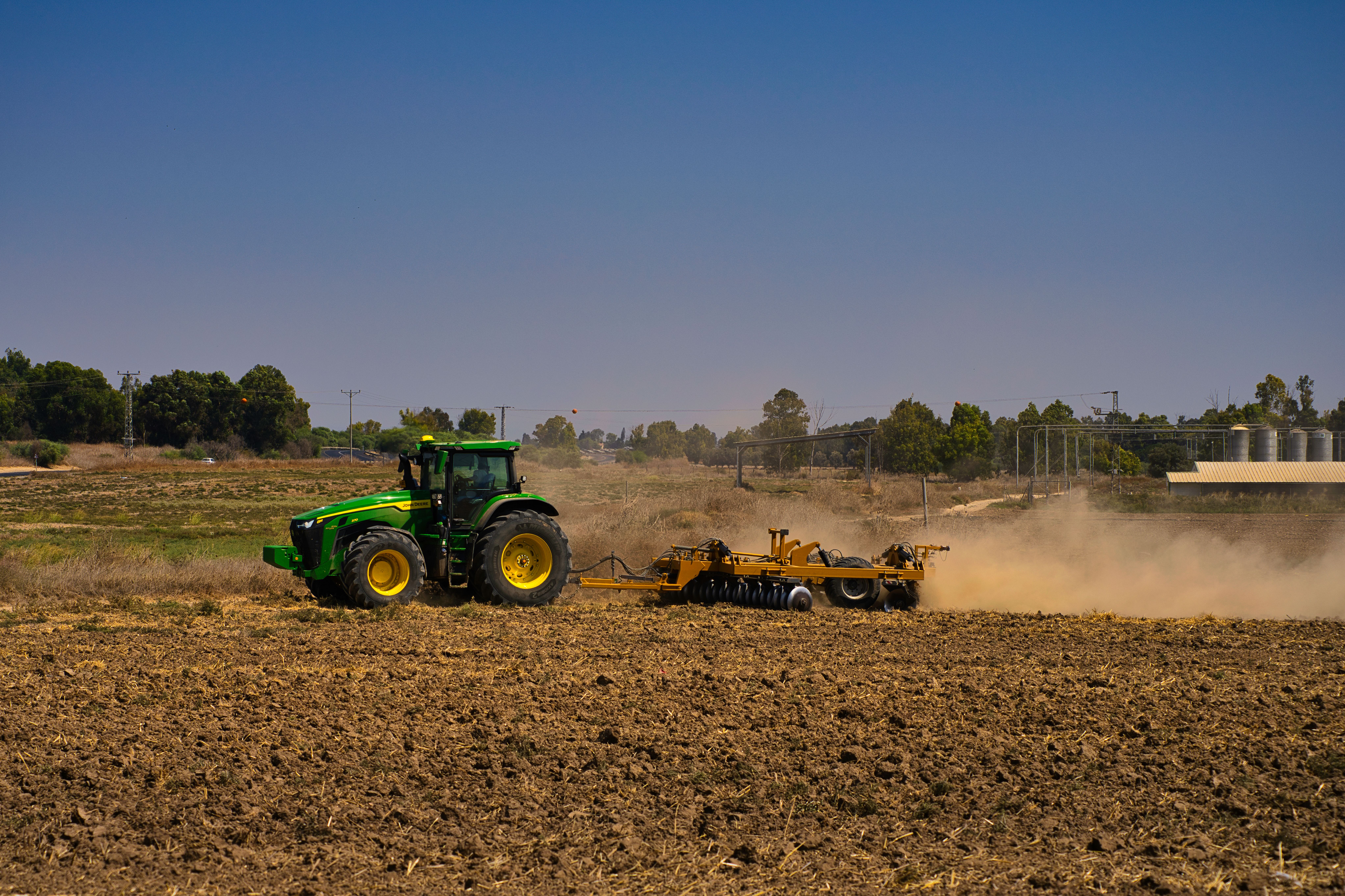 Green Tractor on Brown Field · Free Stock Photo
