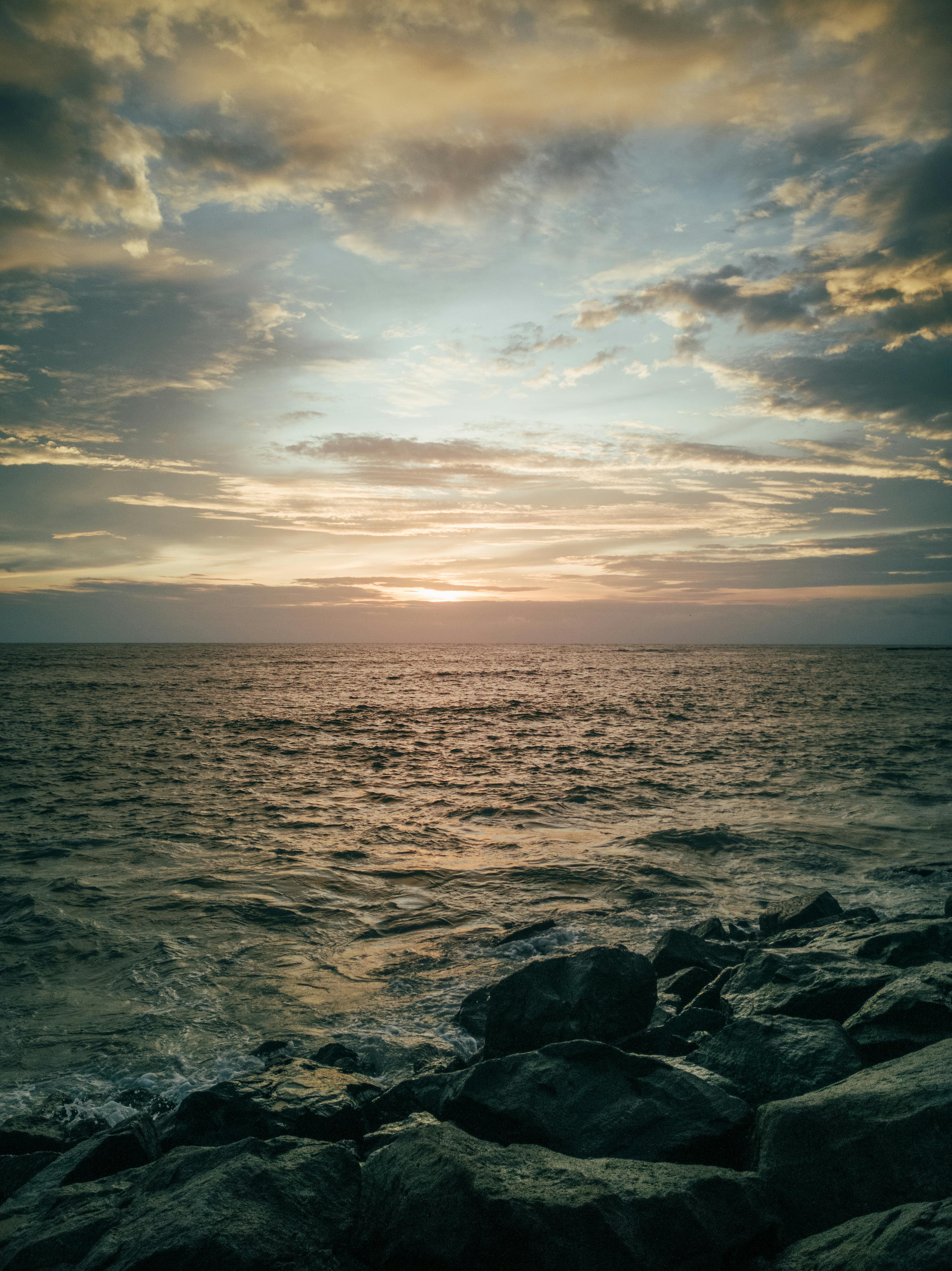 Calm Water on the Sea Under Cloudy Sky · Free Stock Photo