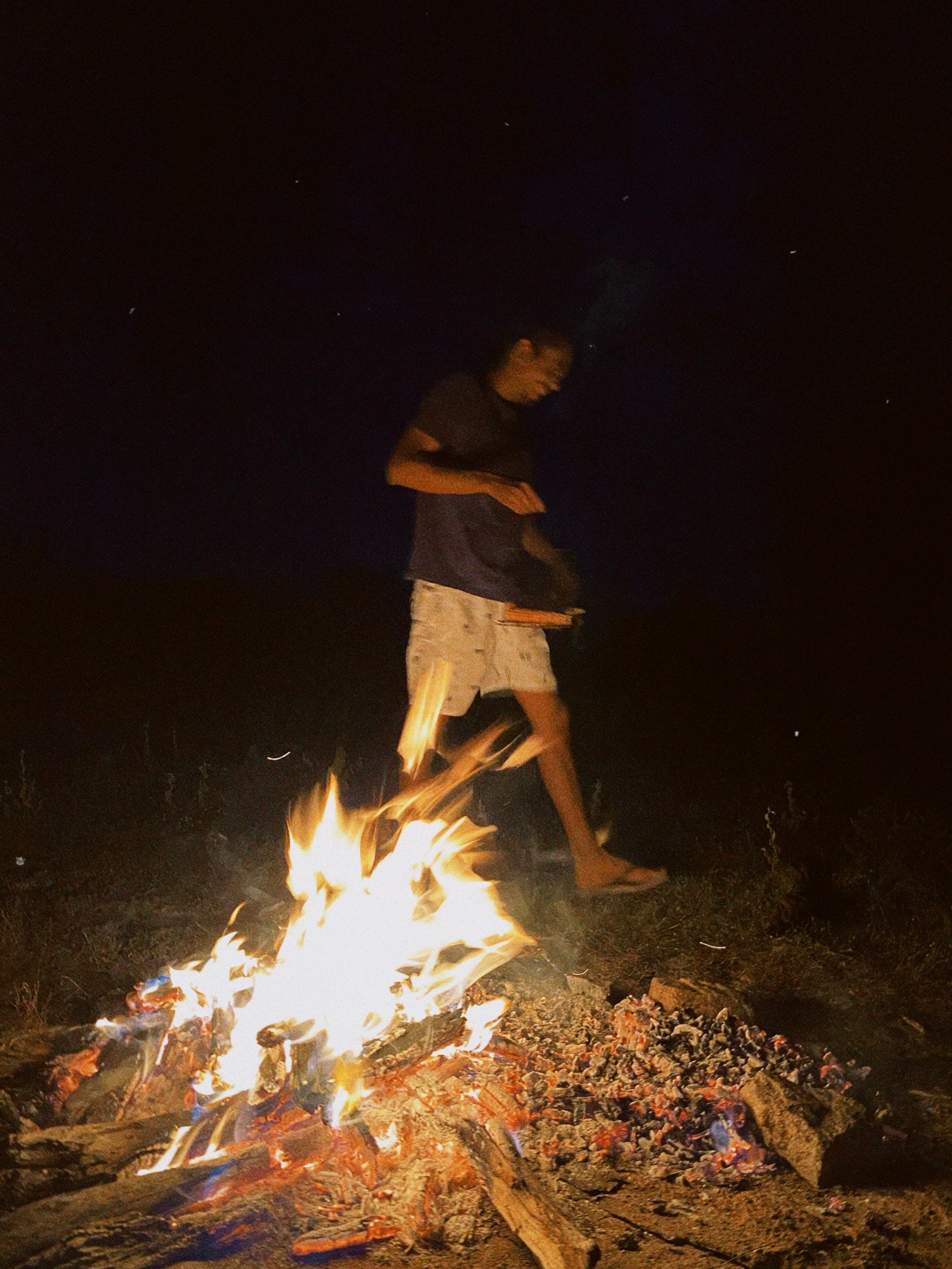 Man Standing Near a Bonfire · Free Stock Photo