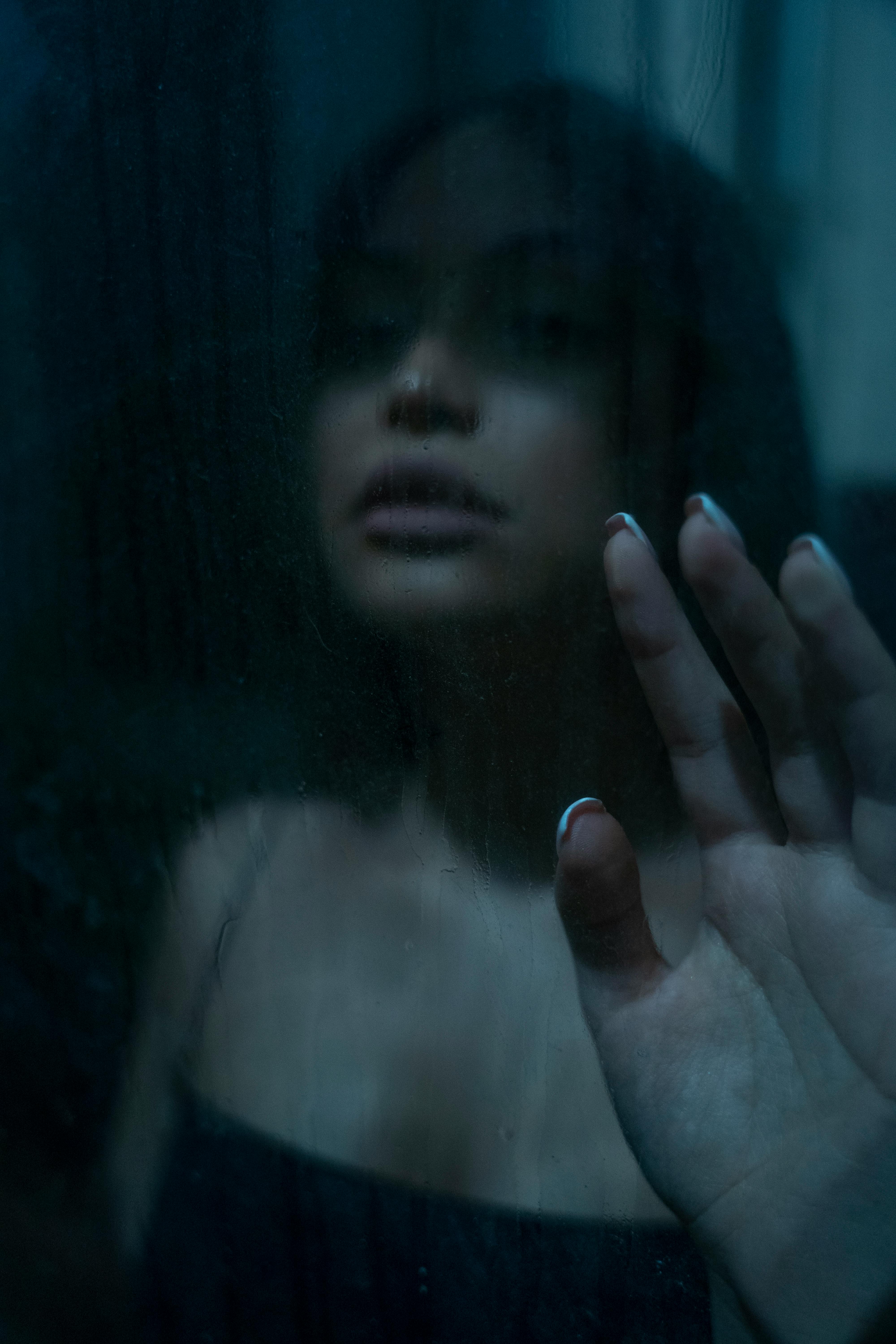 Woman Touching Glass Window · Free Stock Photo