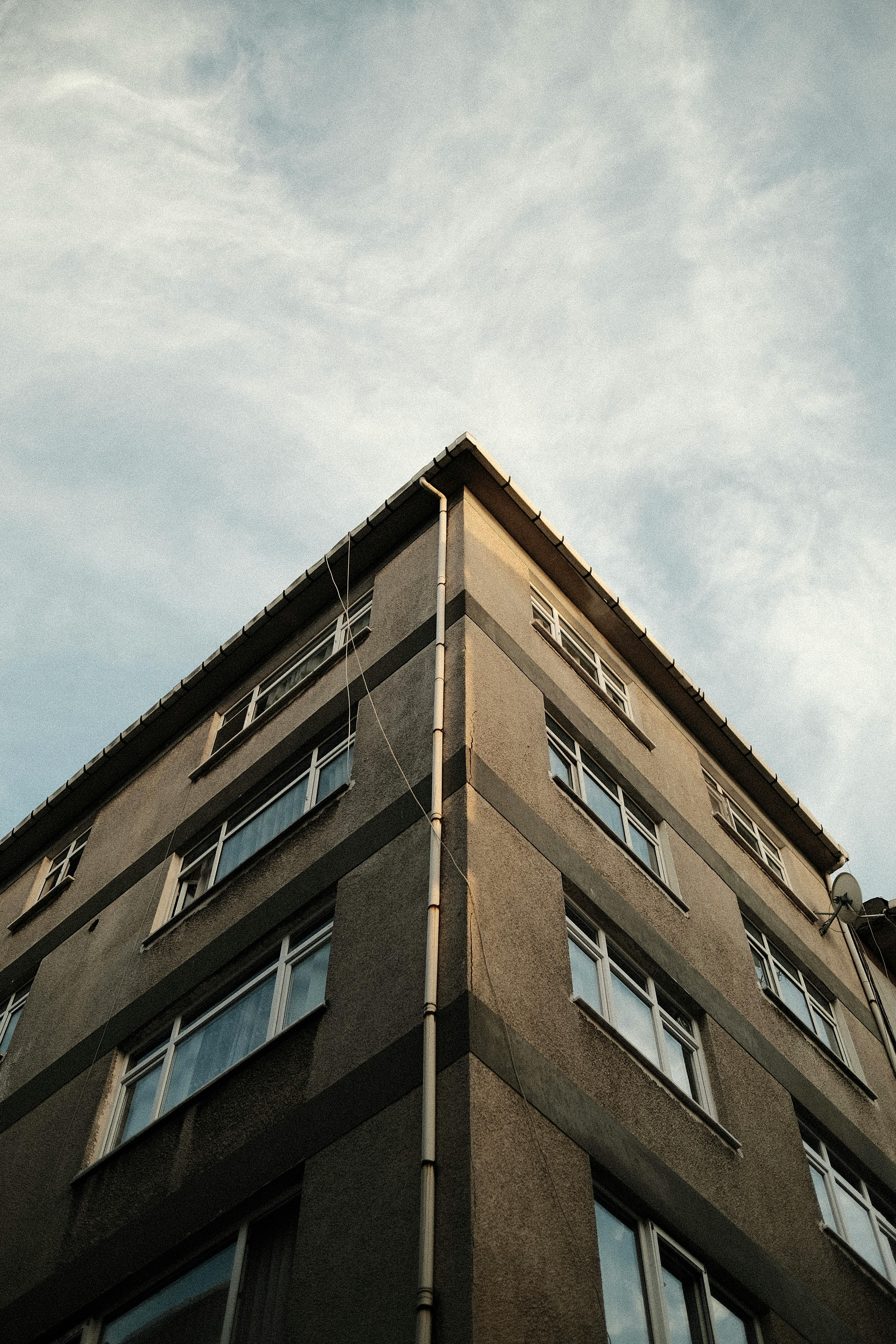 Brown Concrete Building Under White Clouds · Free Stock Photo