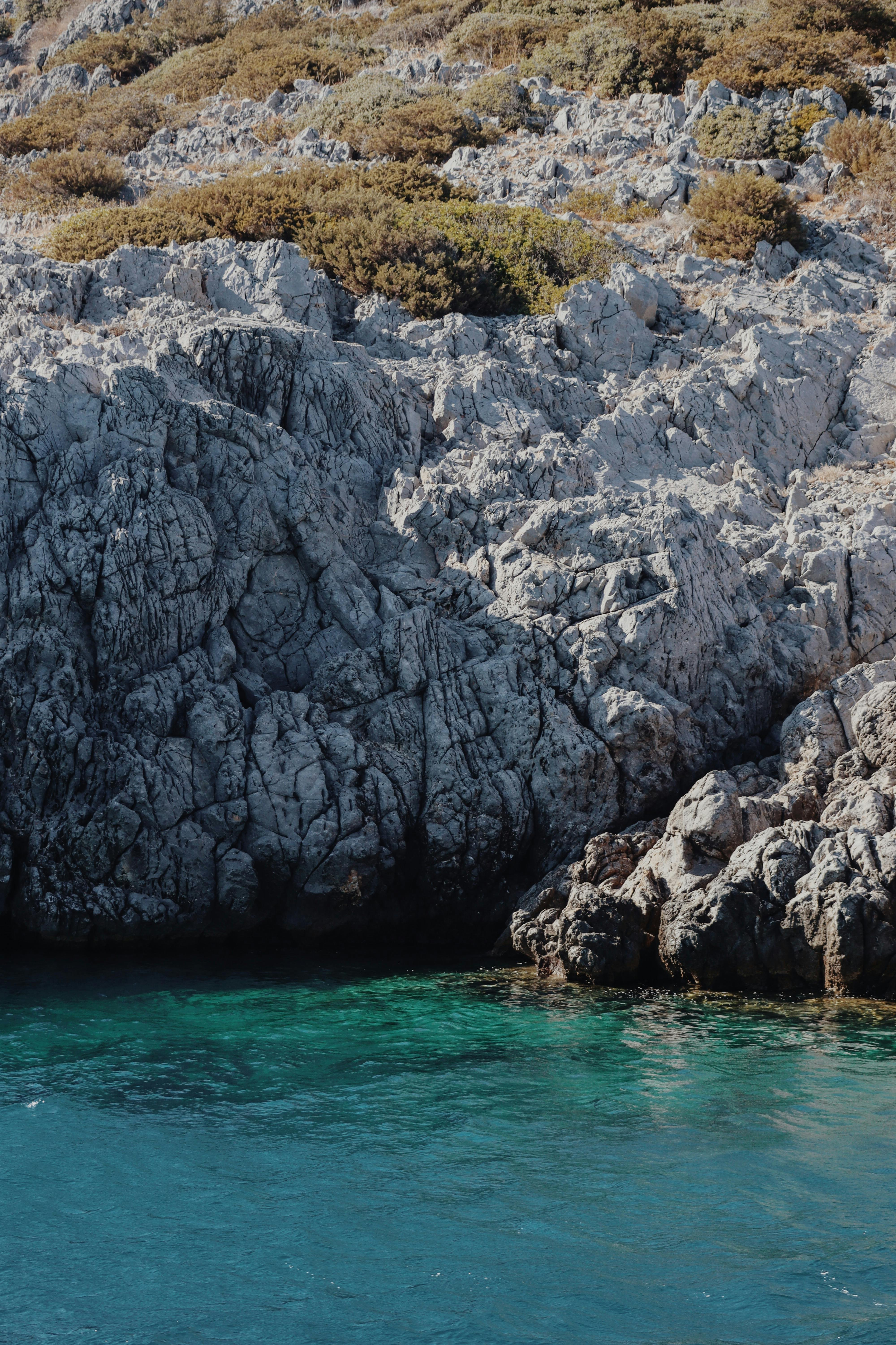 Gray Rocky Mountain Beside the Sea · Free Stock Photo