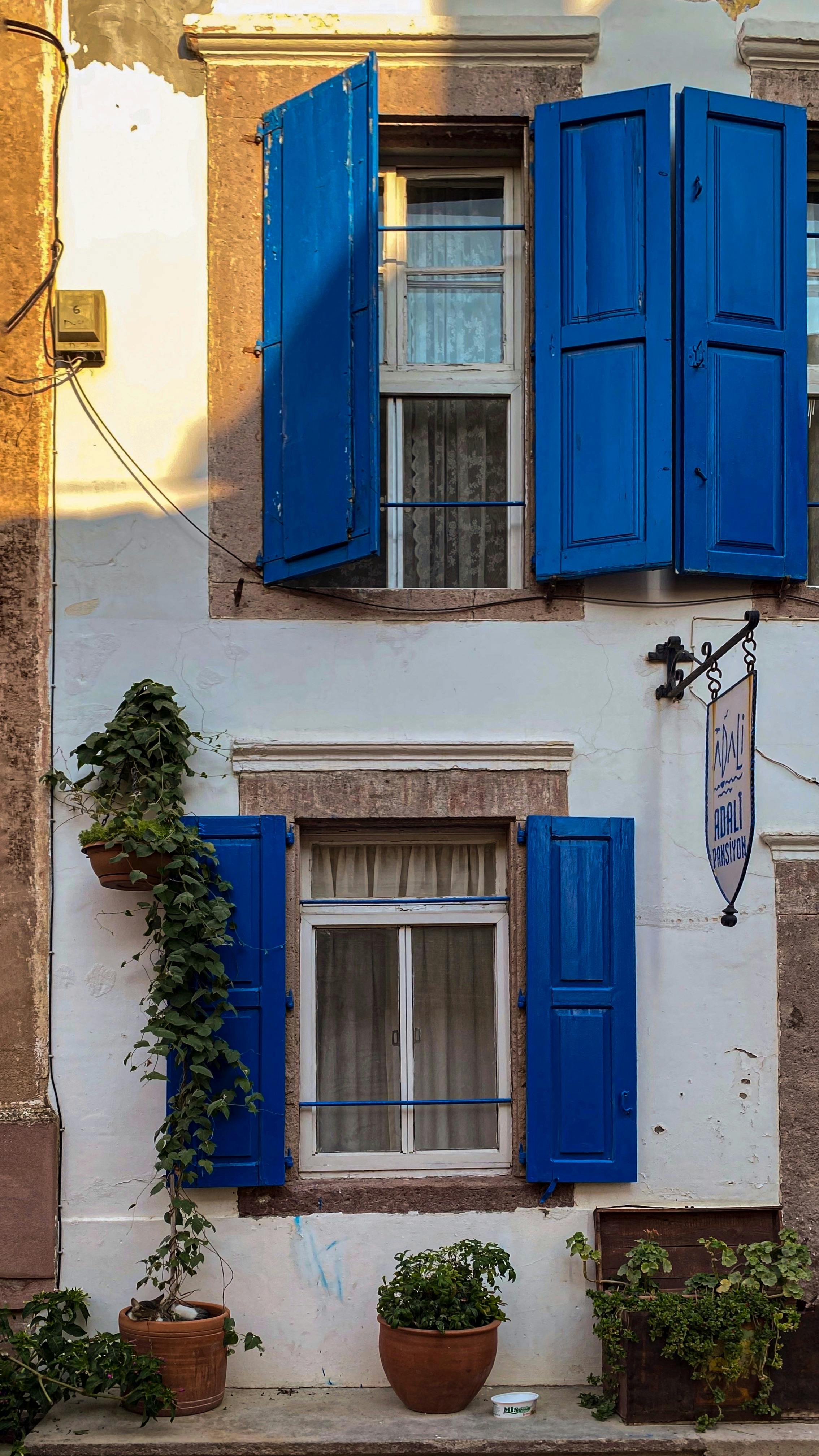 Blue Window Shutters on White Concrete Building · Free Stock Photo