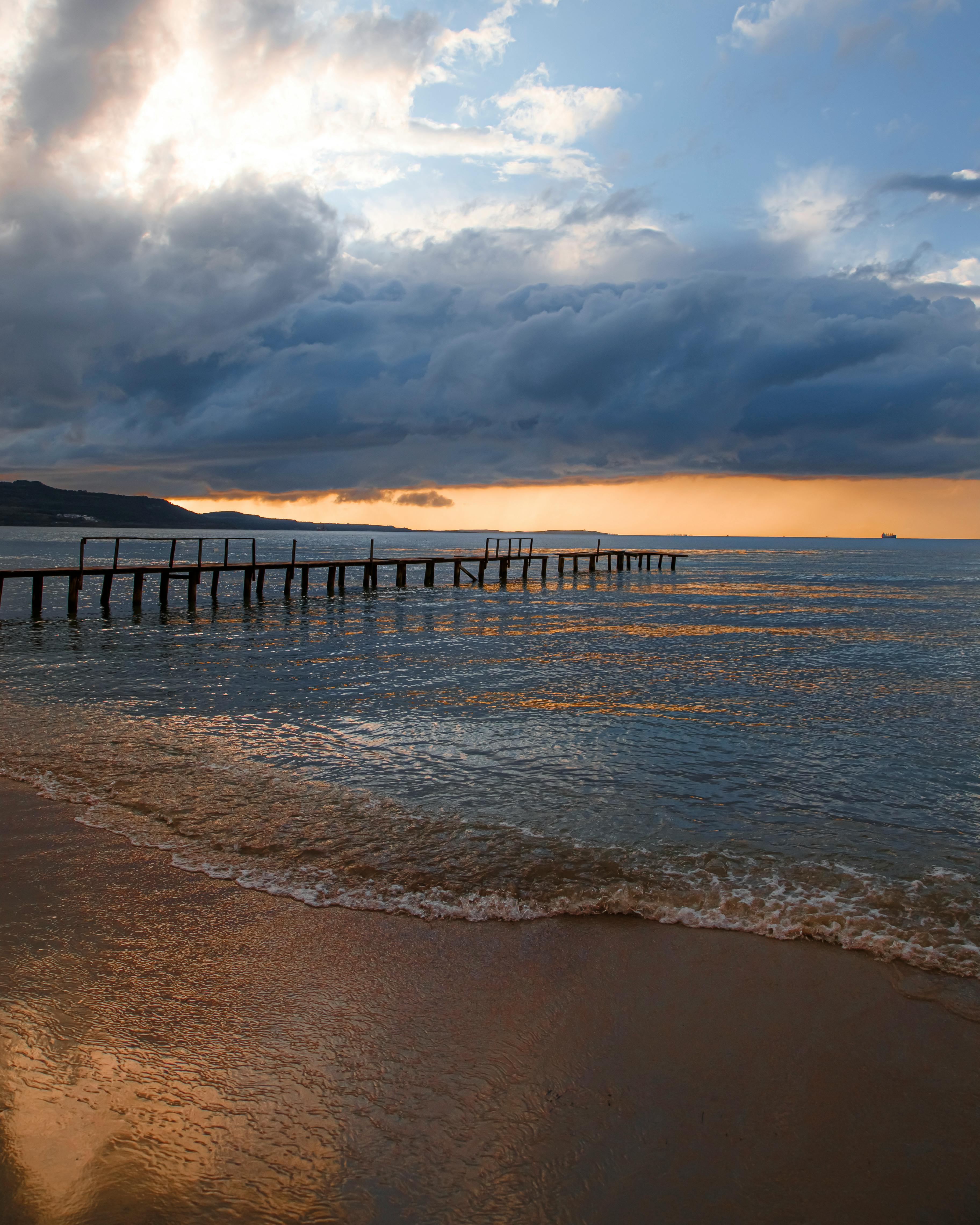 Brown Wooden Dock on Sea Under White Clouds and Blue Sky · Free Stock Photo