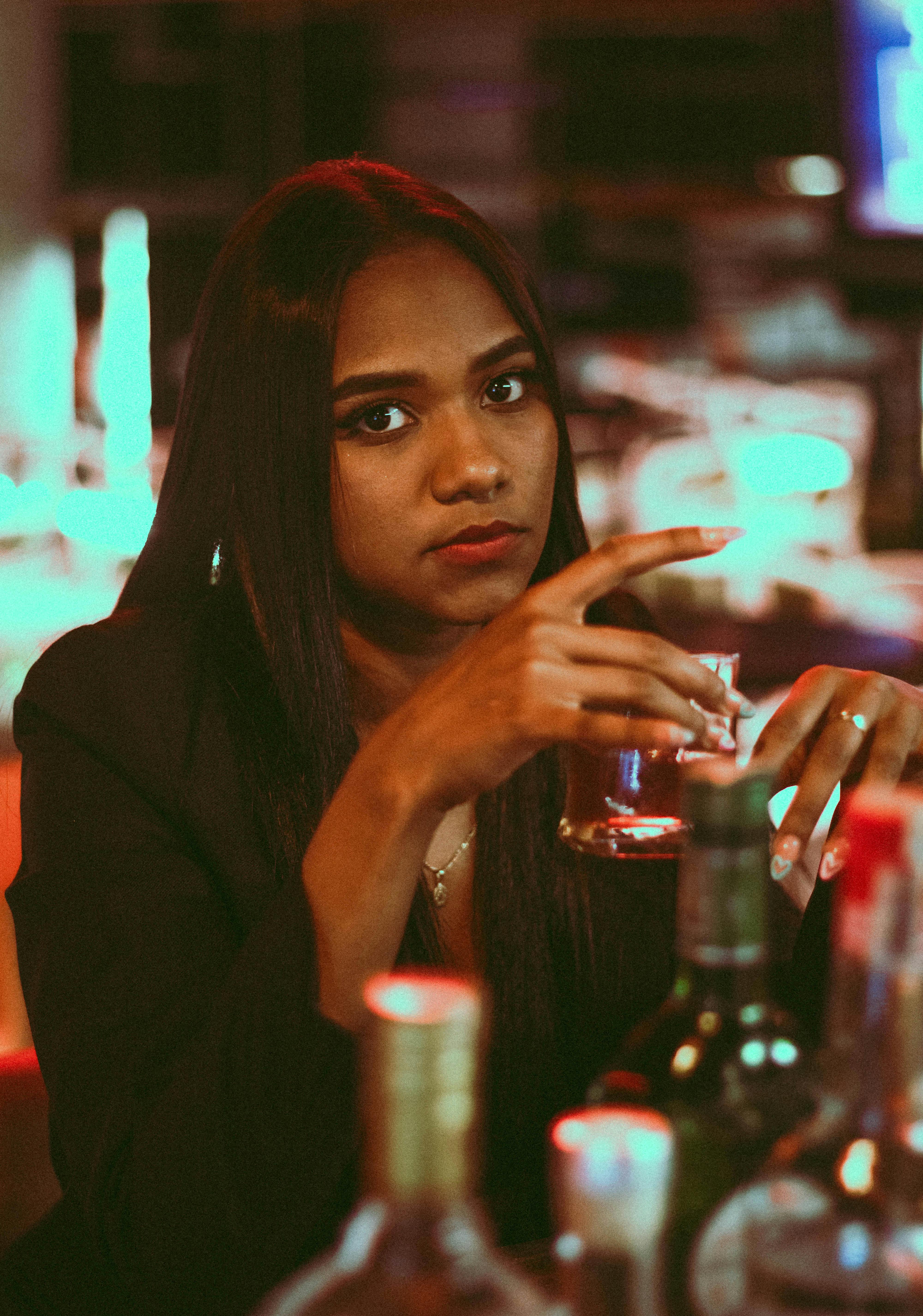 A Woman in Black Blazer Holding Cocktail Drink · Free Stock Photo