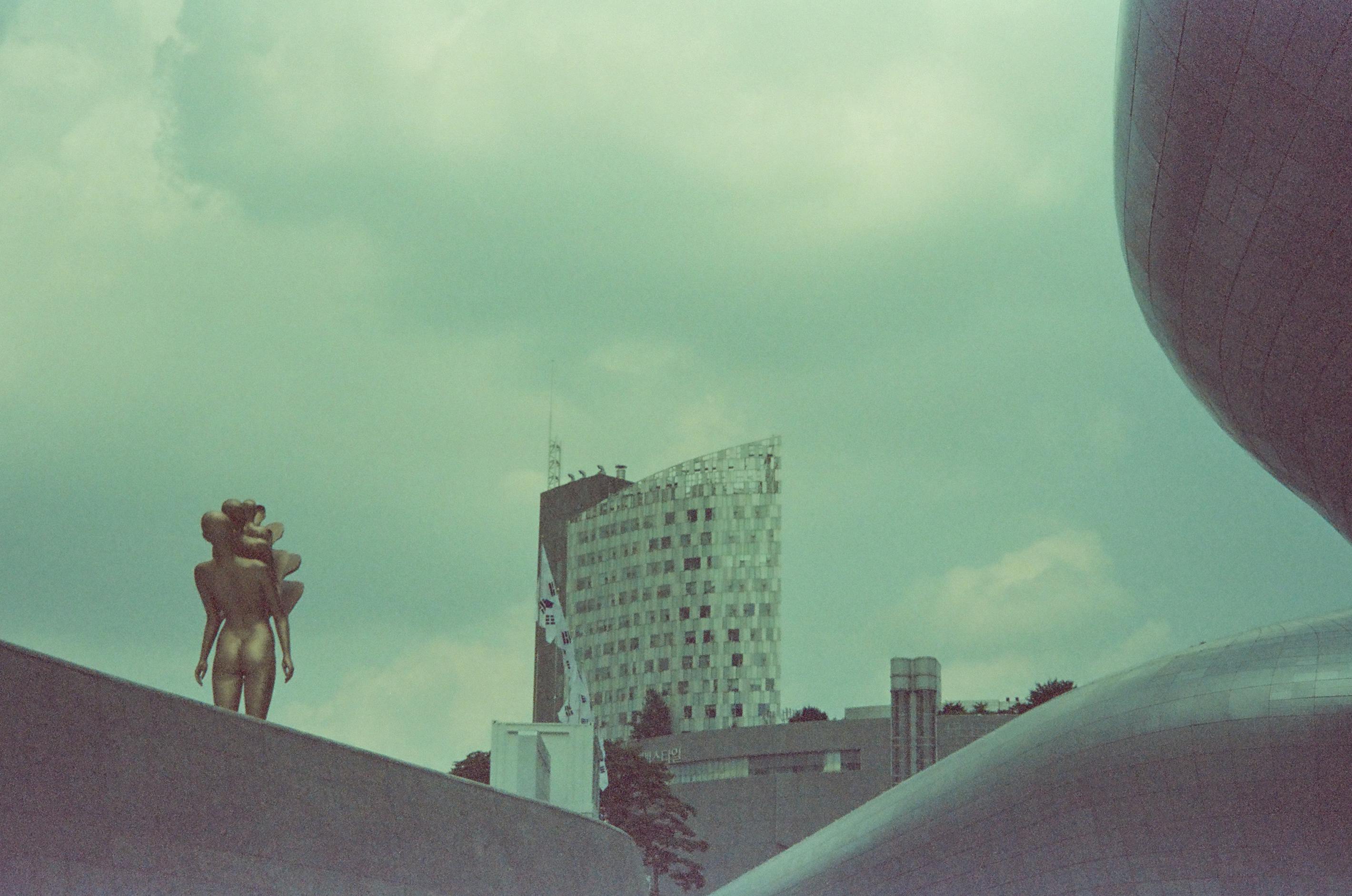 Sculpture in front of High Rise Building against Cloudy Sky · Free ...