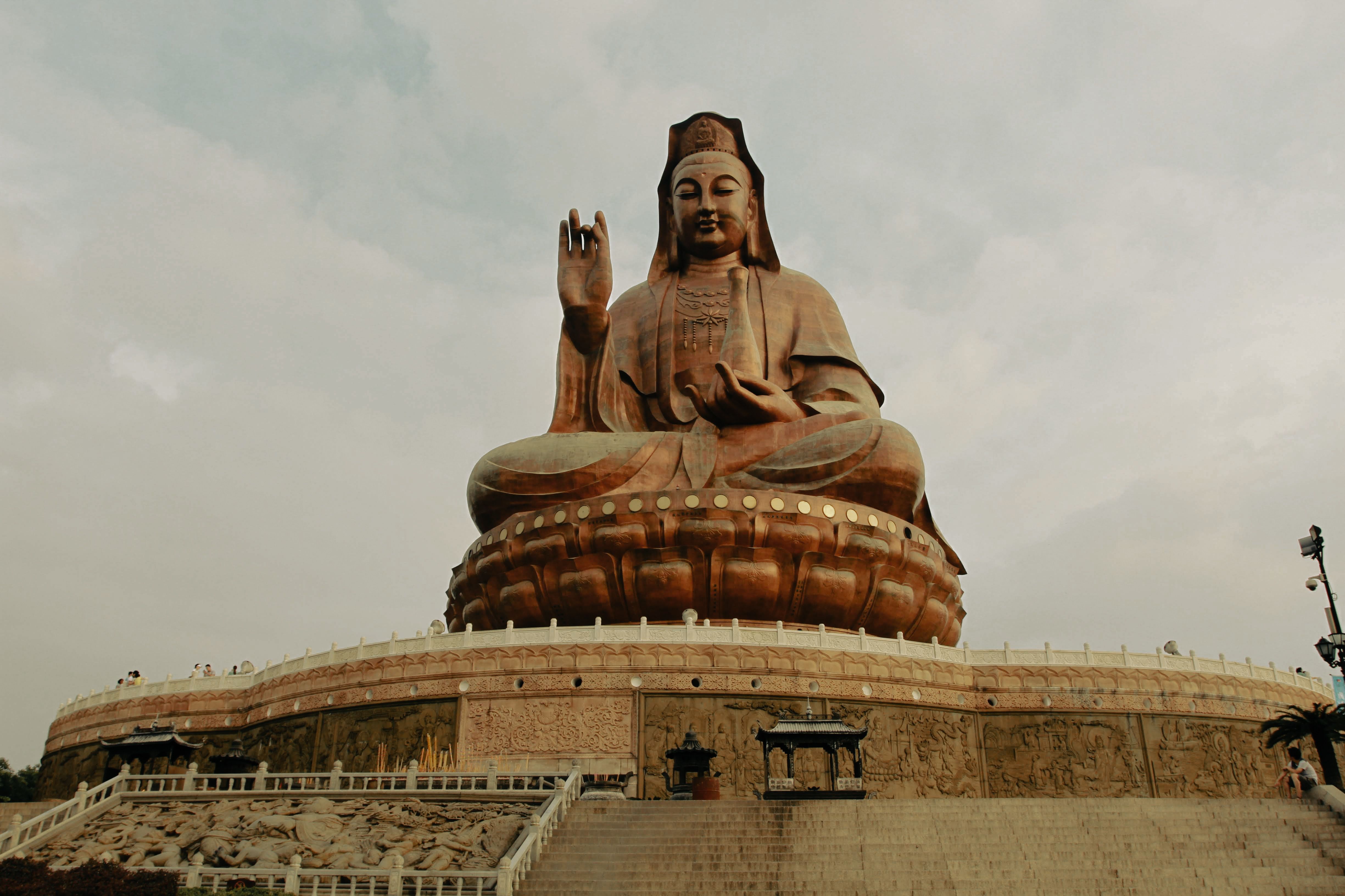 Brown Concrete Statue Under White Sky · Free Stock Photo
