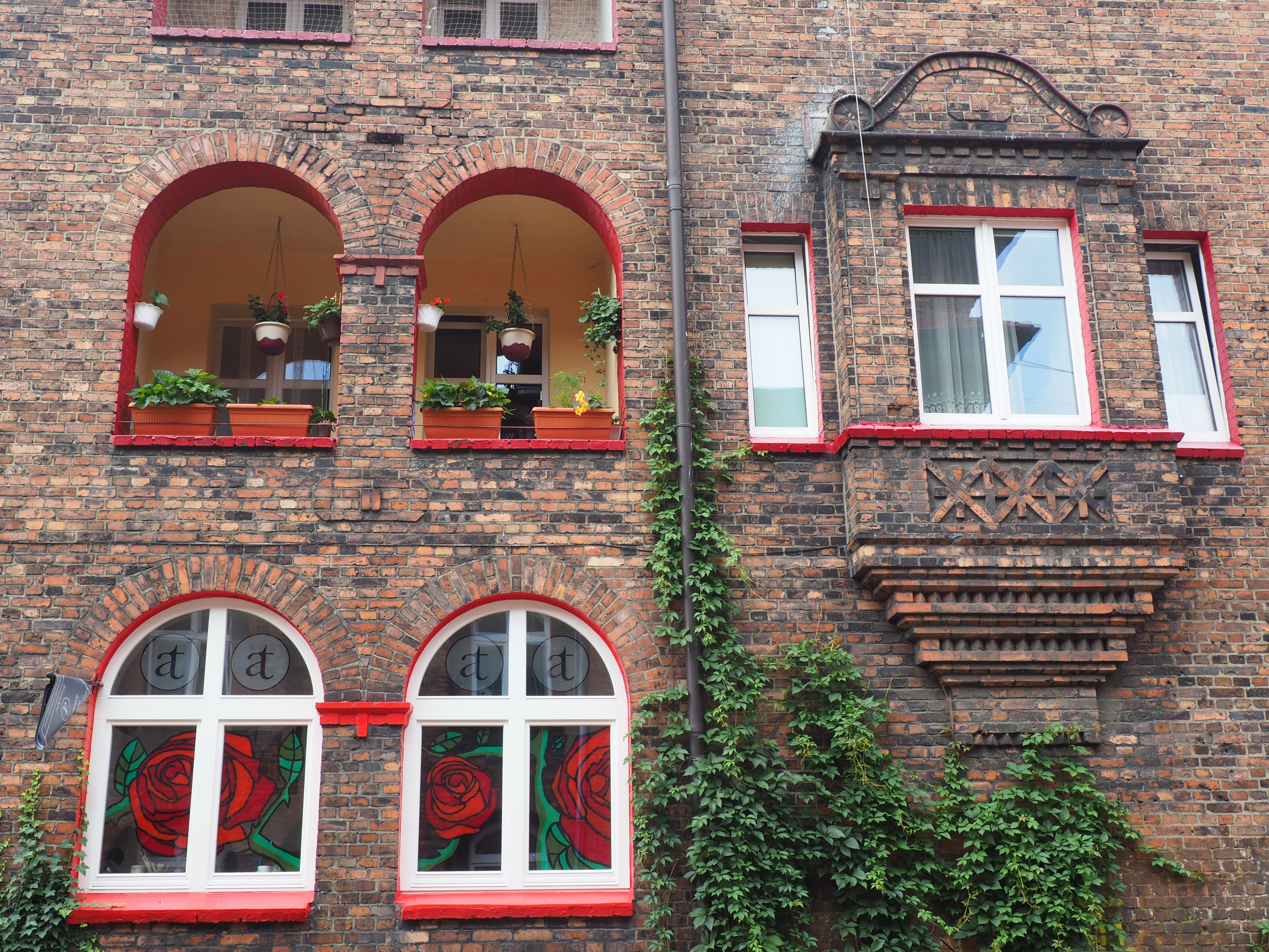 Arched Windows and Glass Window on a Brick Building · Free Stock Photo