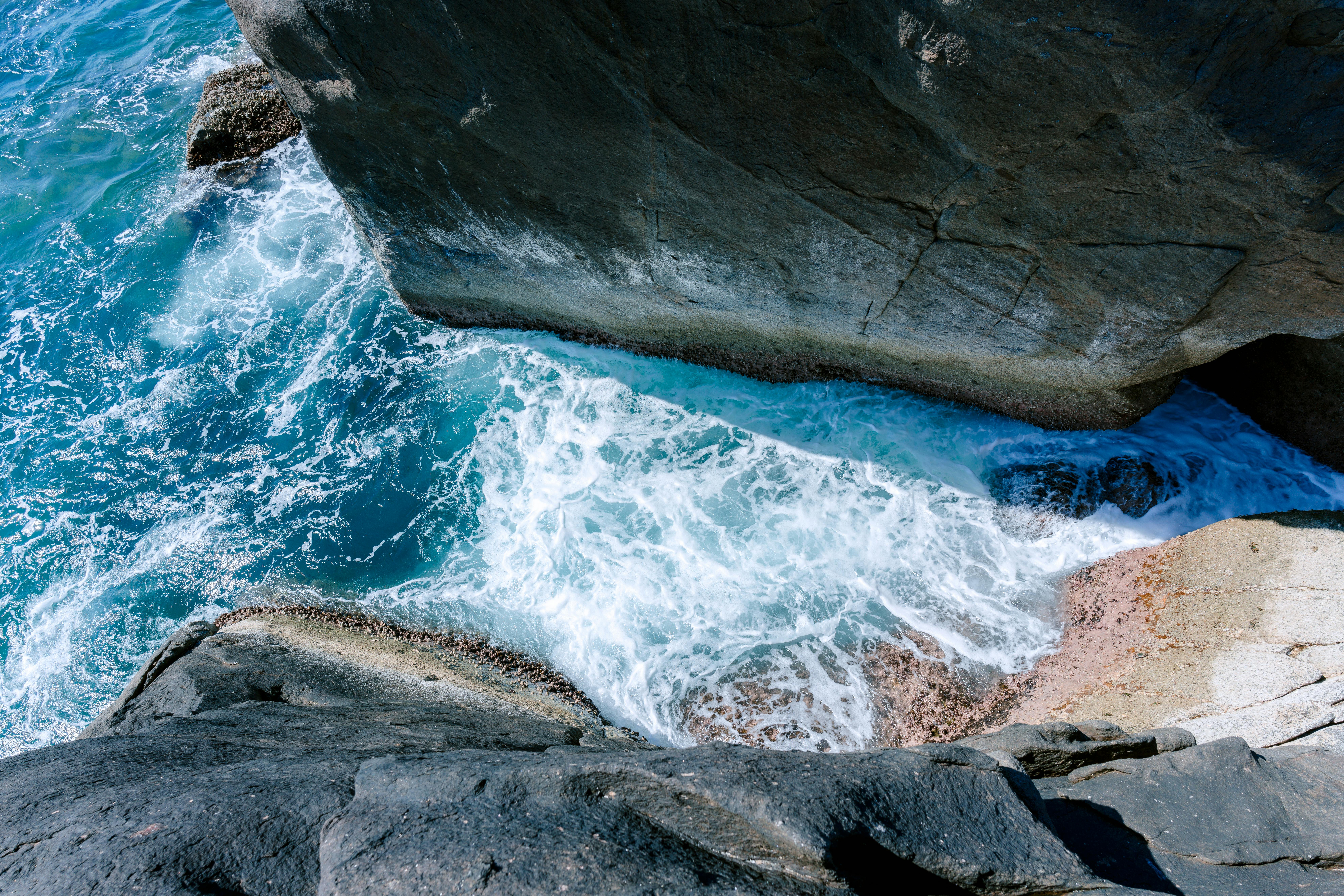 An Aerial Photography of an Ocean Between Rock Formations · Free Stock ...