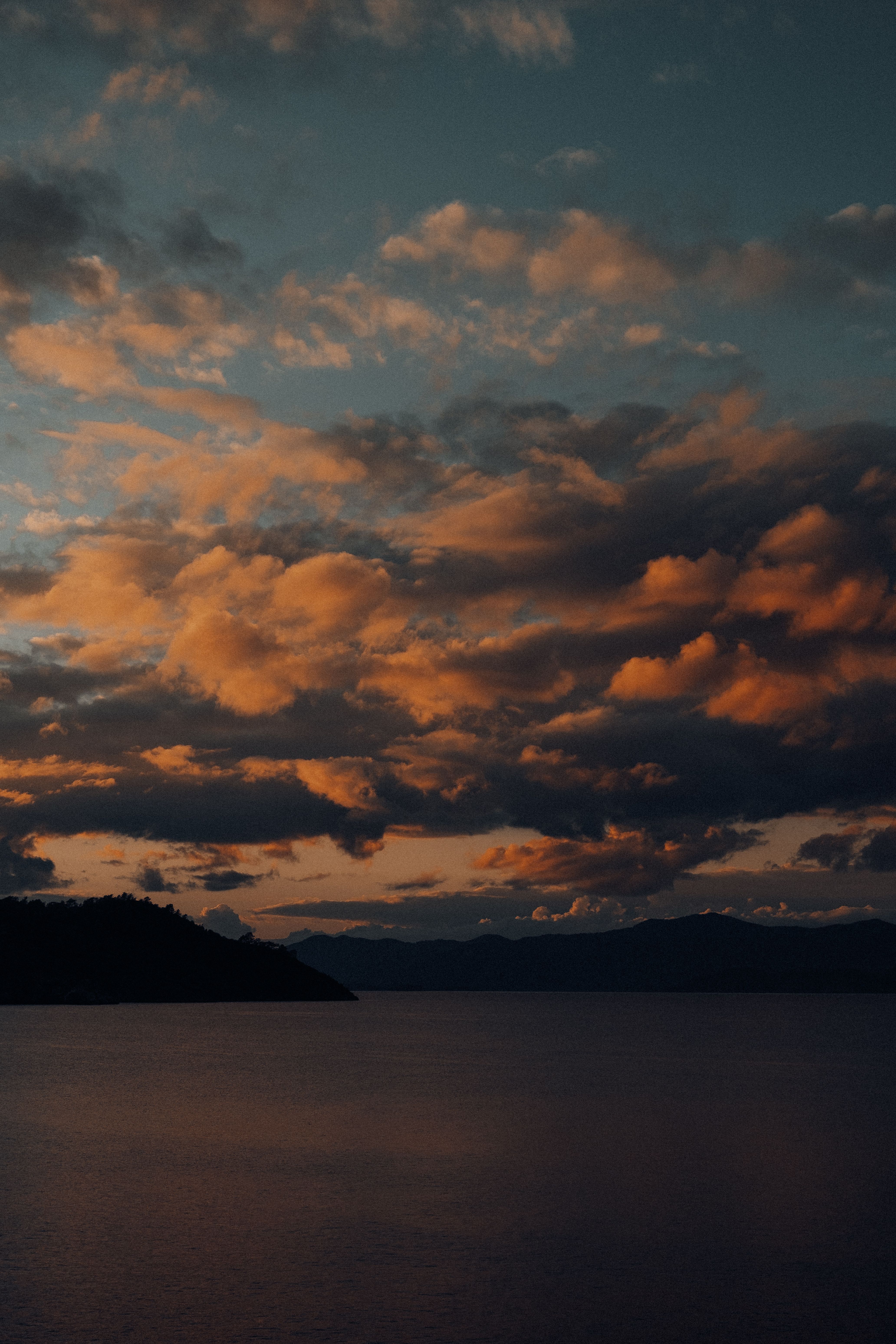Photo of the Cloudy Sky above Water at Dawn · Free Stock Photo