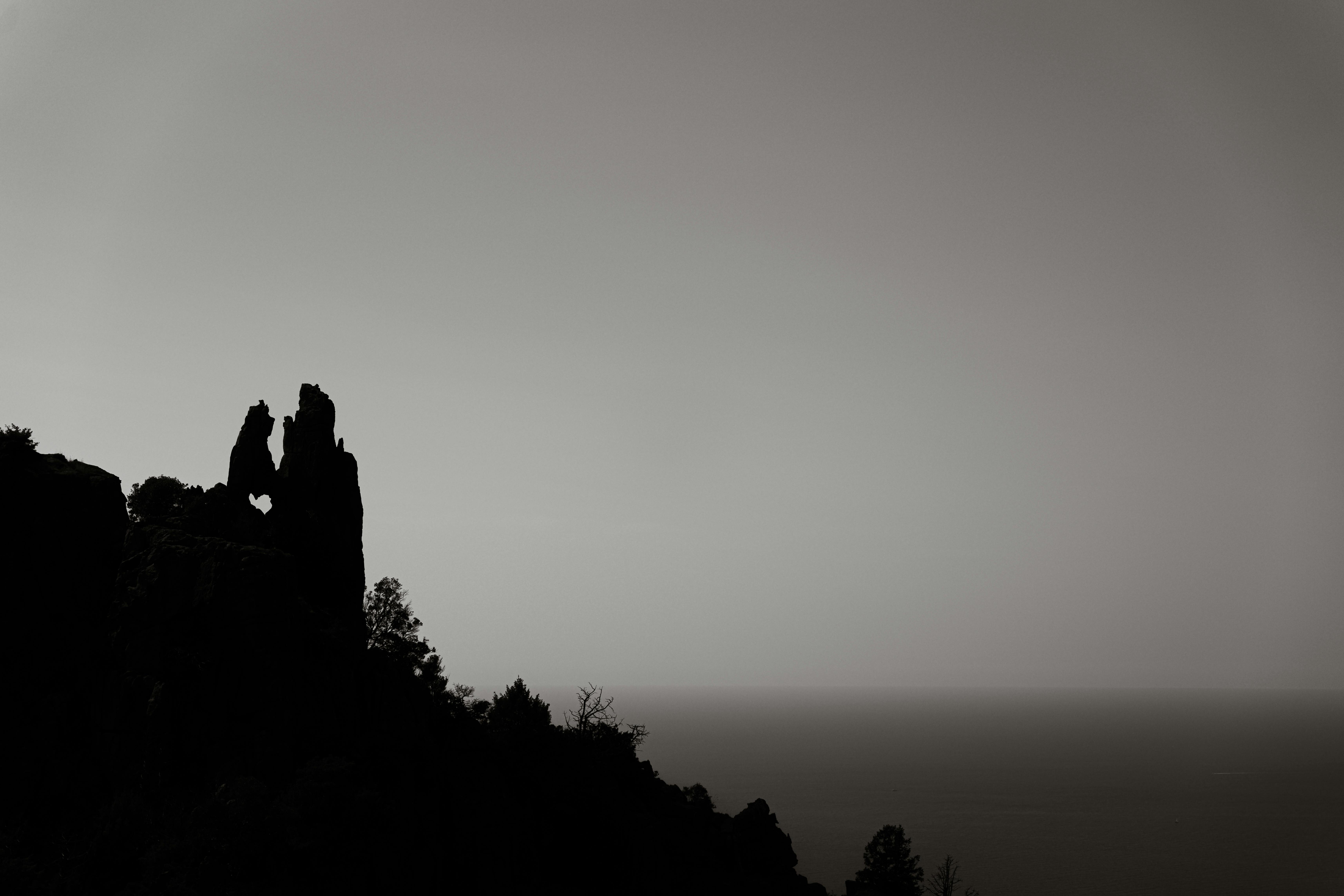 Man Sitting on Cliff · Free Stock Photo