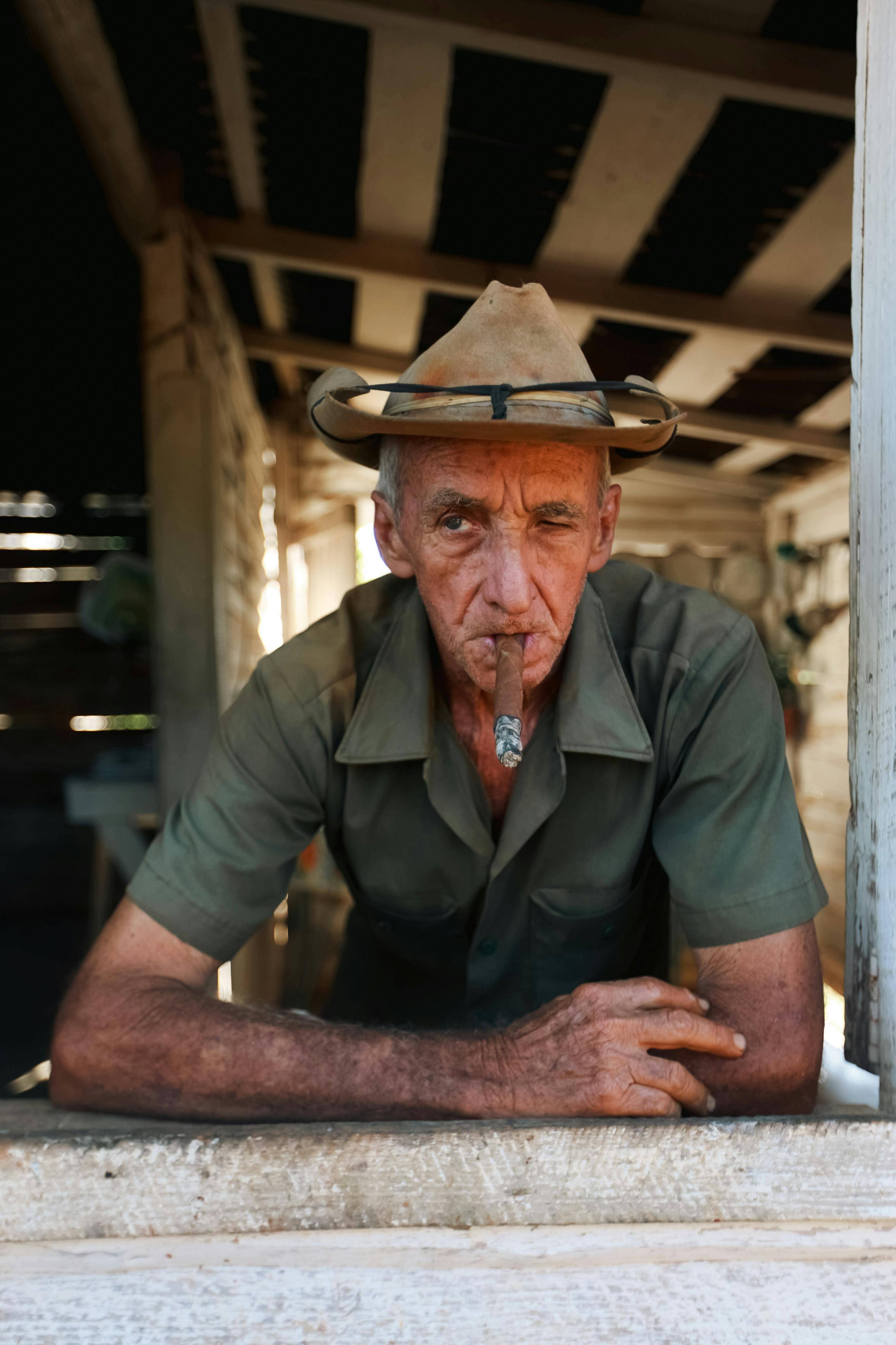 Back View of a Man Wearing a Cowboy Hat Looking a Sea through a Window ...