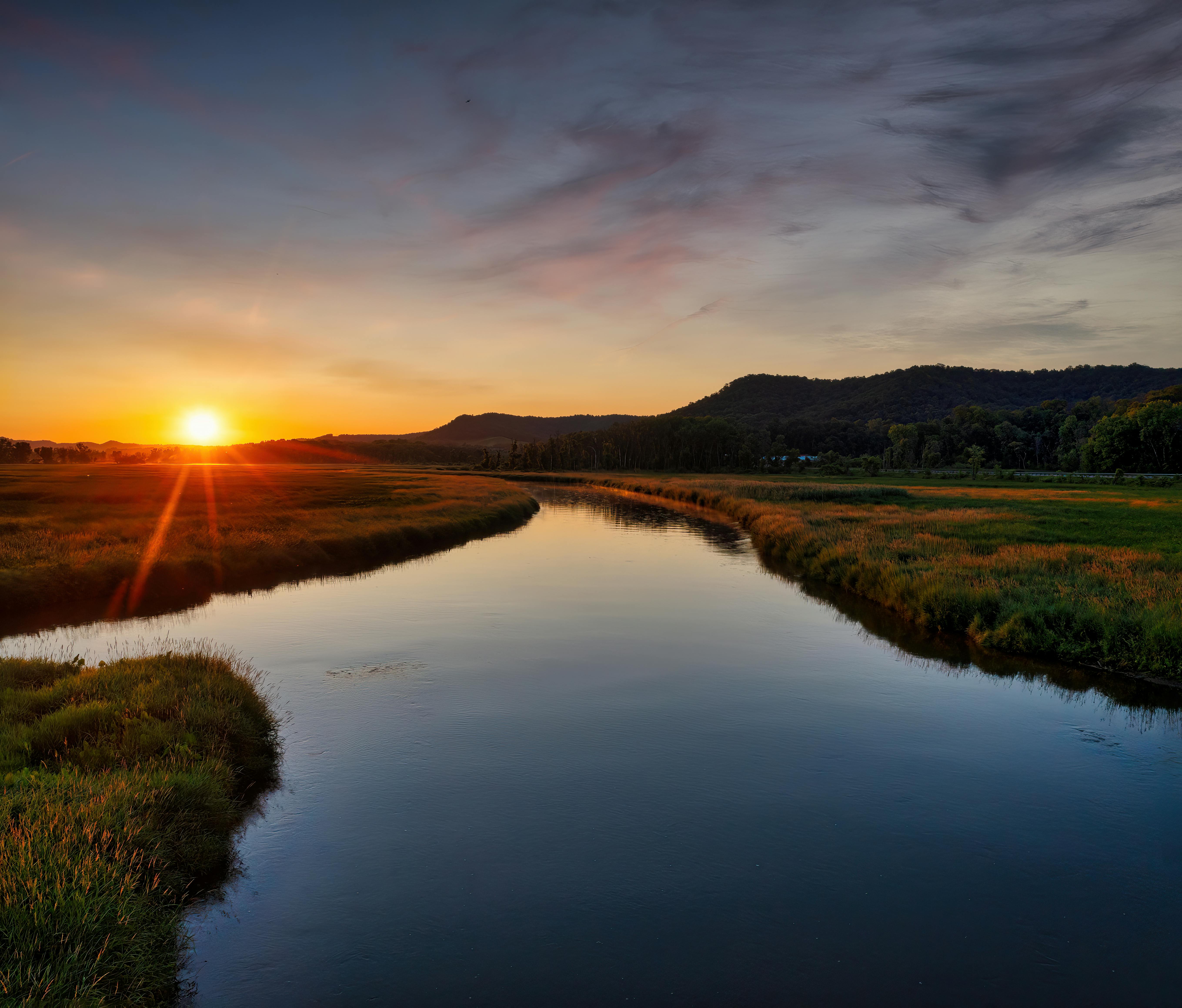 Sun Setting over the River and a Grass Field · Free Stock Photo