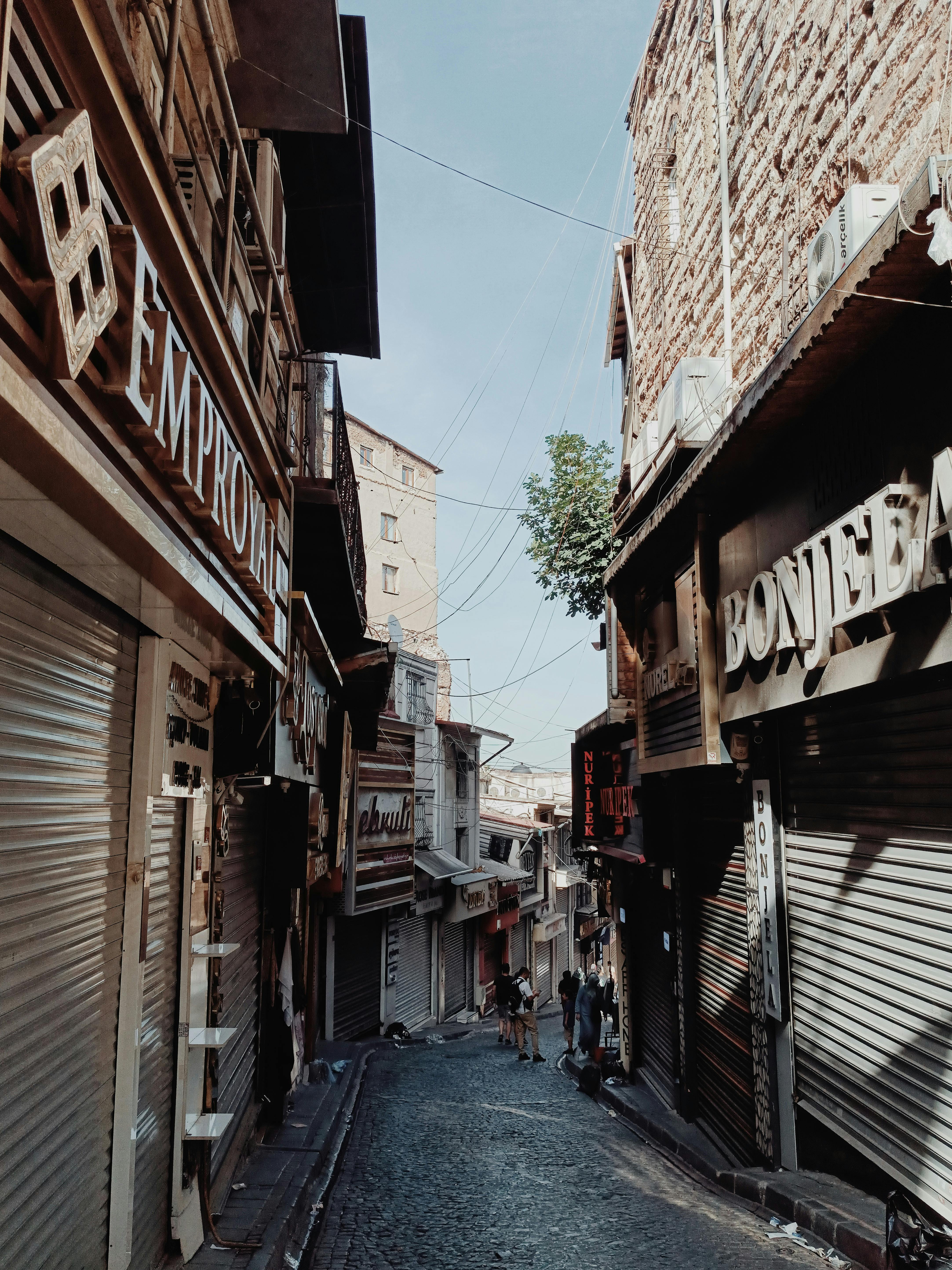 A Narrow Paved Alley Between Stores in an Old Town · Free Stock Photo