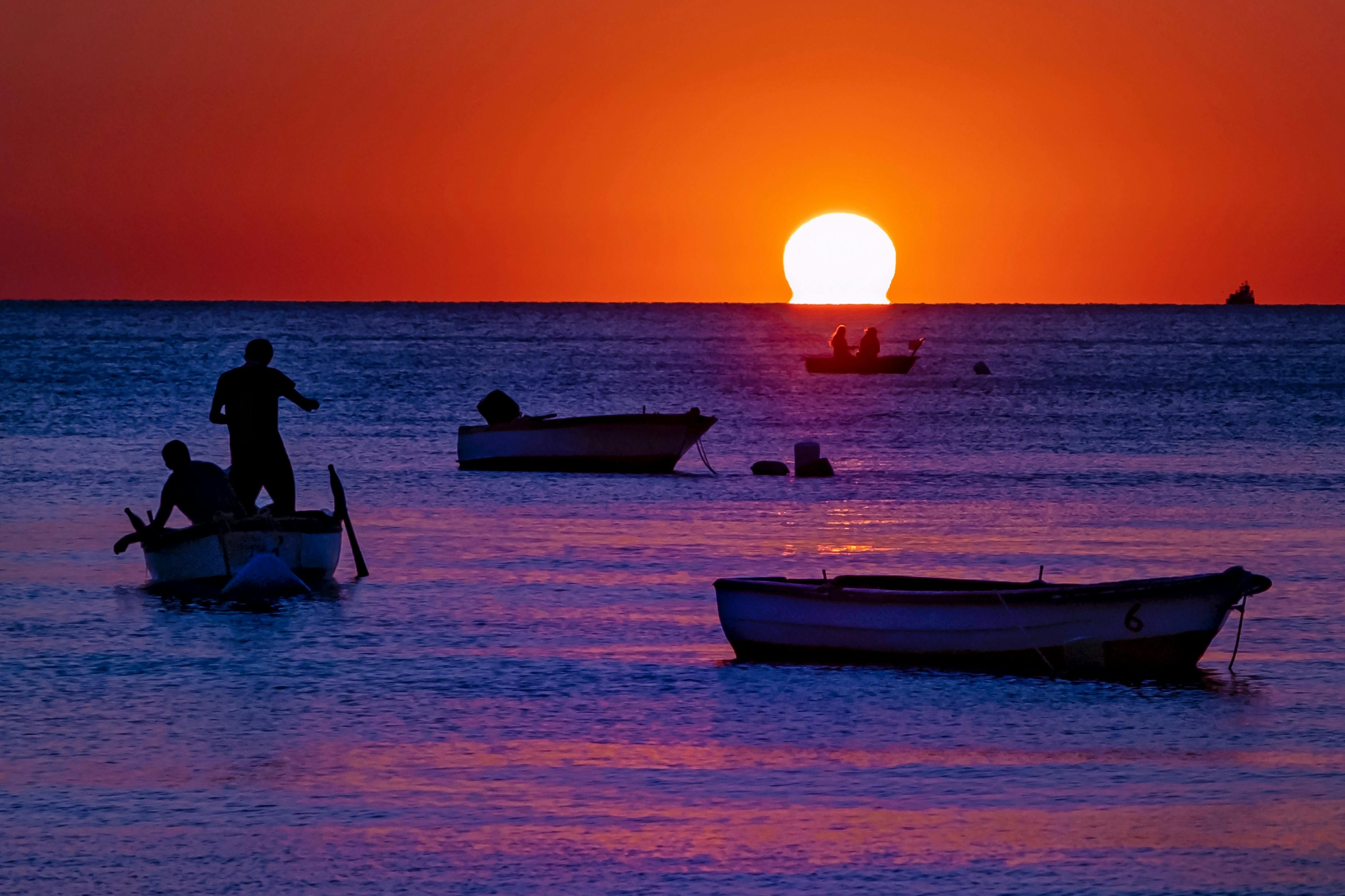 Silhouette of People Riding Boats on Water during Daytime · Free Stock ...