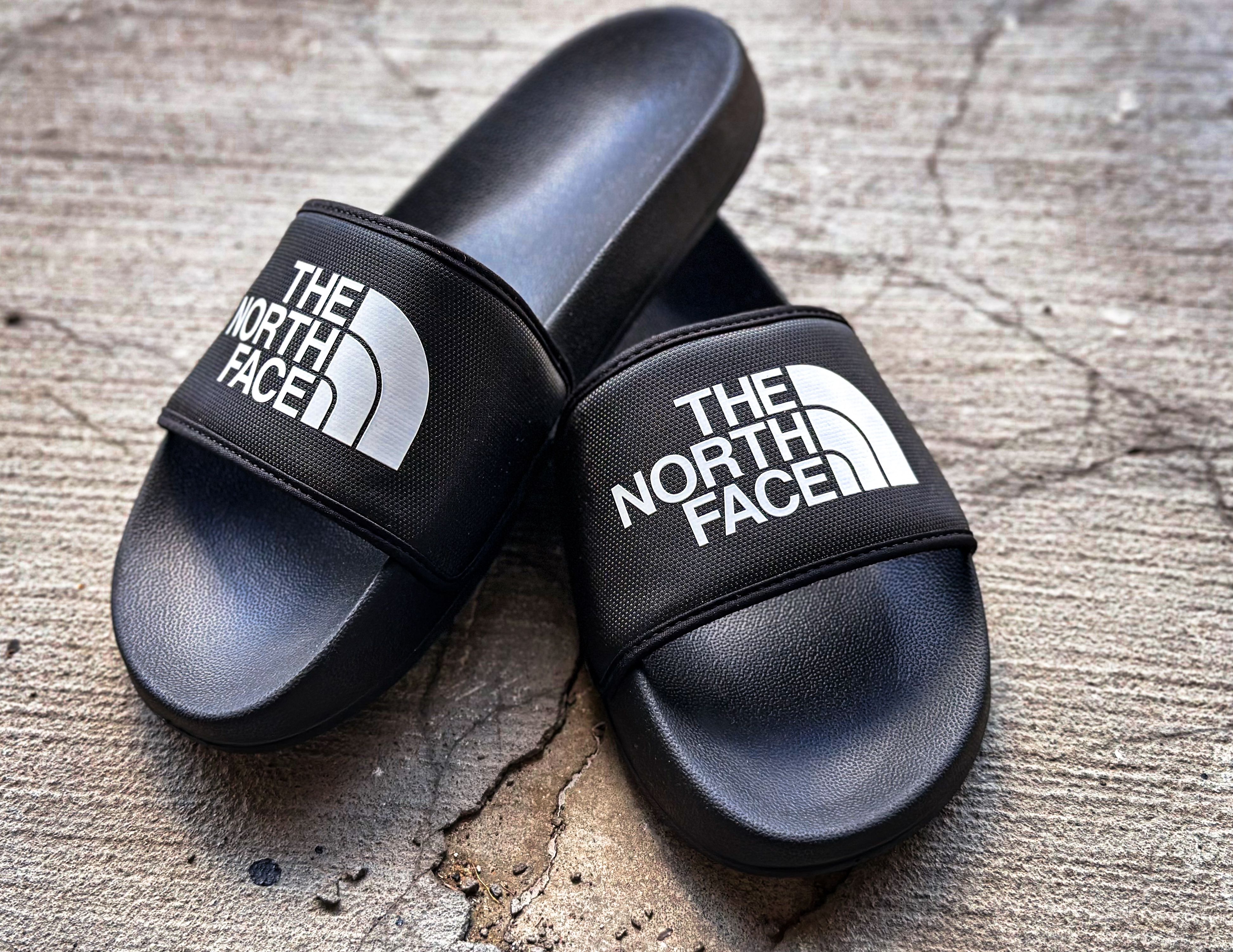 Close-Up Shot of Black Sandals on Concrete Surface · Free Stock Photo
