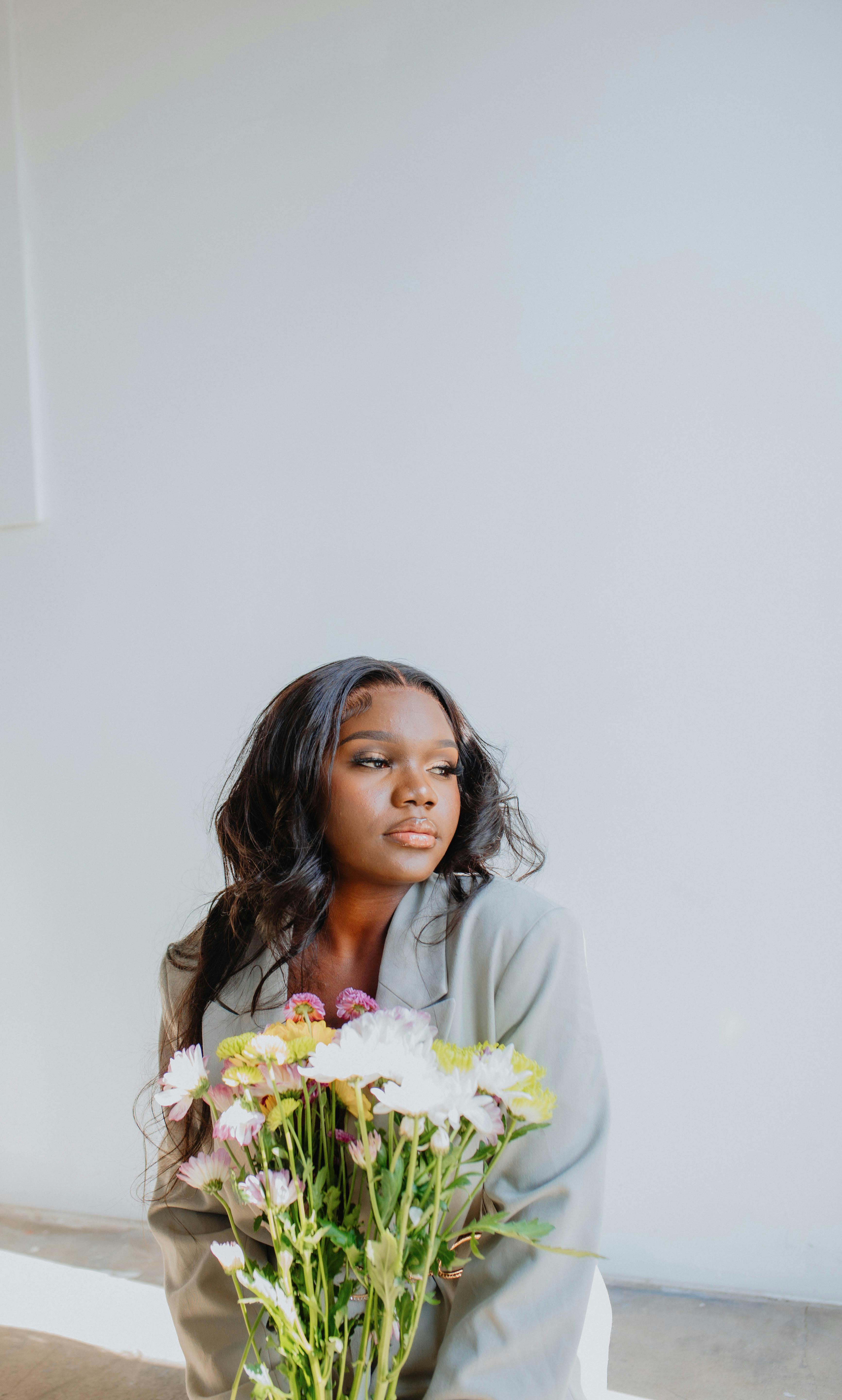 Woman with Dreadlocks Posing with Flowers · Free Stock Photo