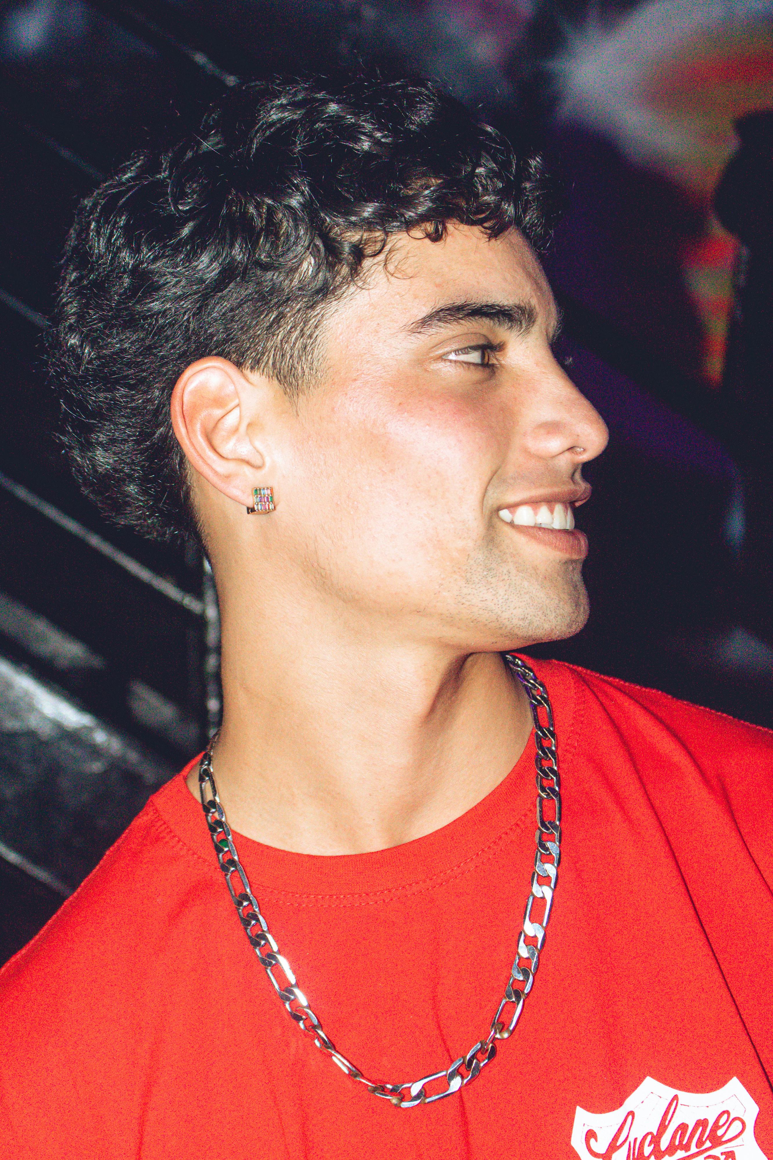 Man Wearing Red Jacket Holding his Chains · Free Stock Photo